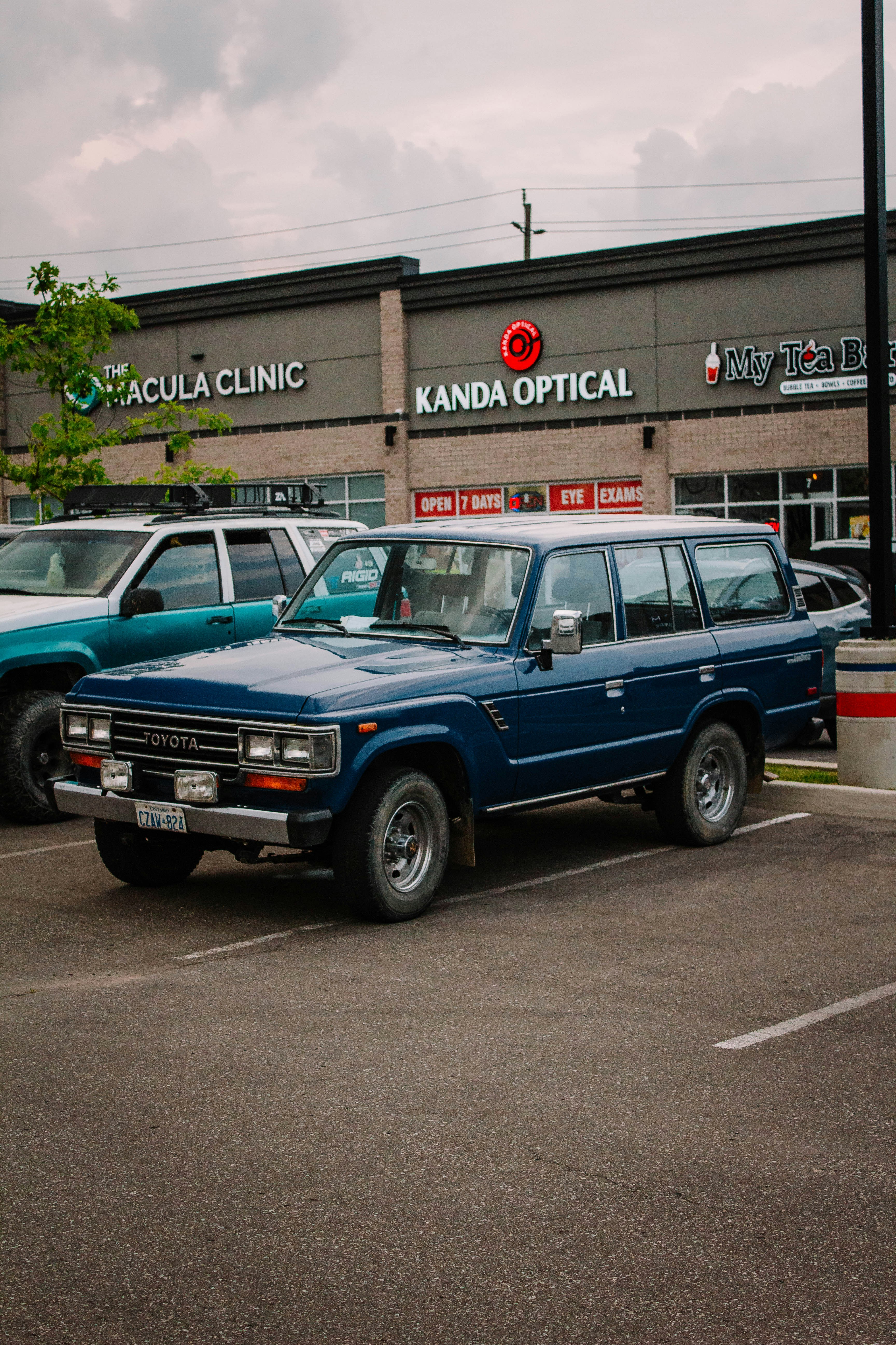 Blue Toyota in a Row: A Parking Lot Portrait Outside the Optical Clinic