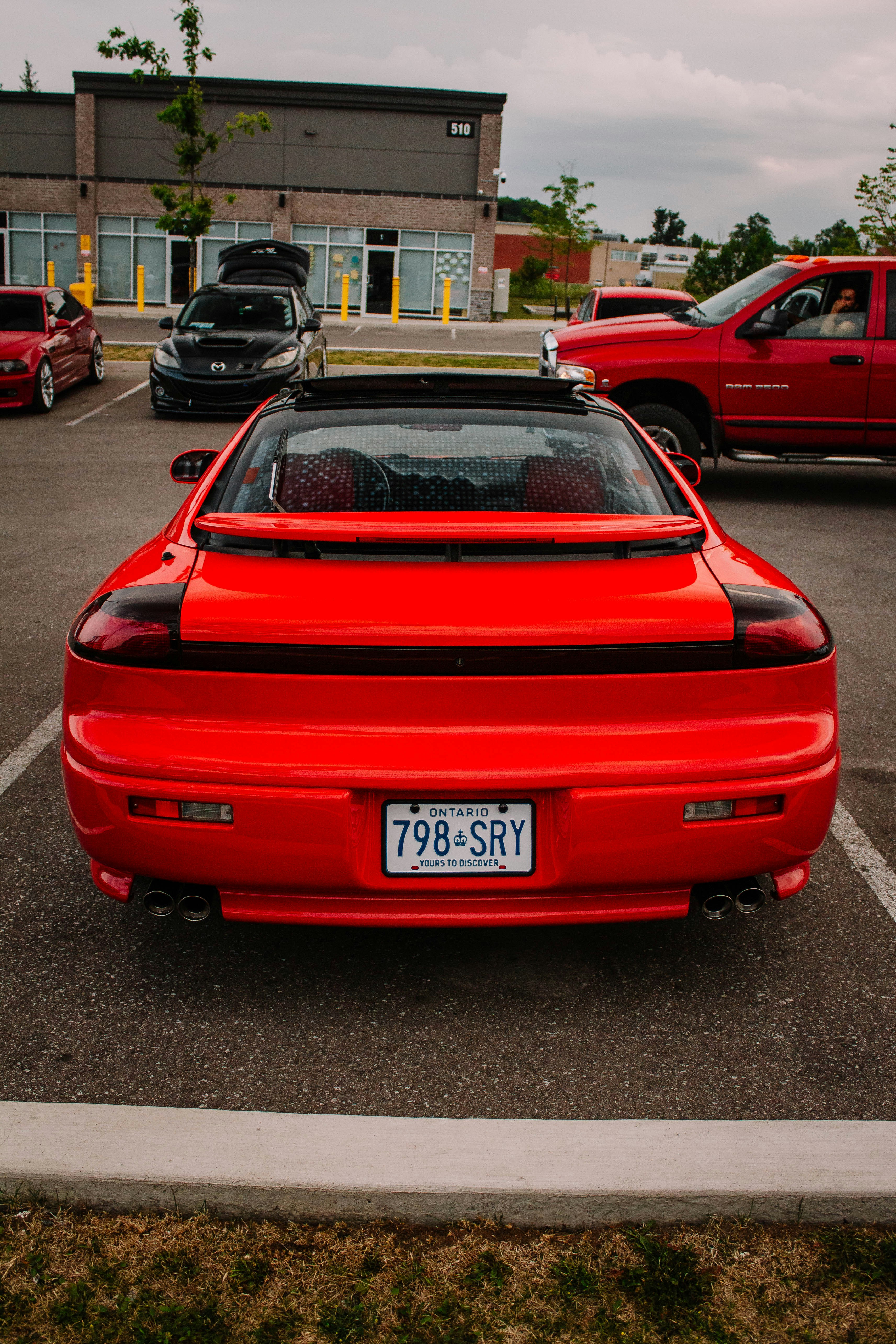 Scarlet Drive: A Coupe's Bold Stance in the Parking Lot