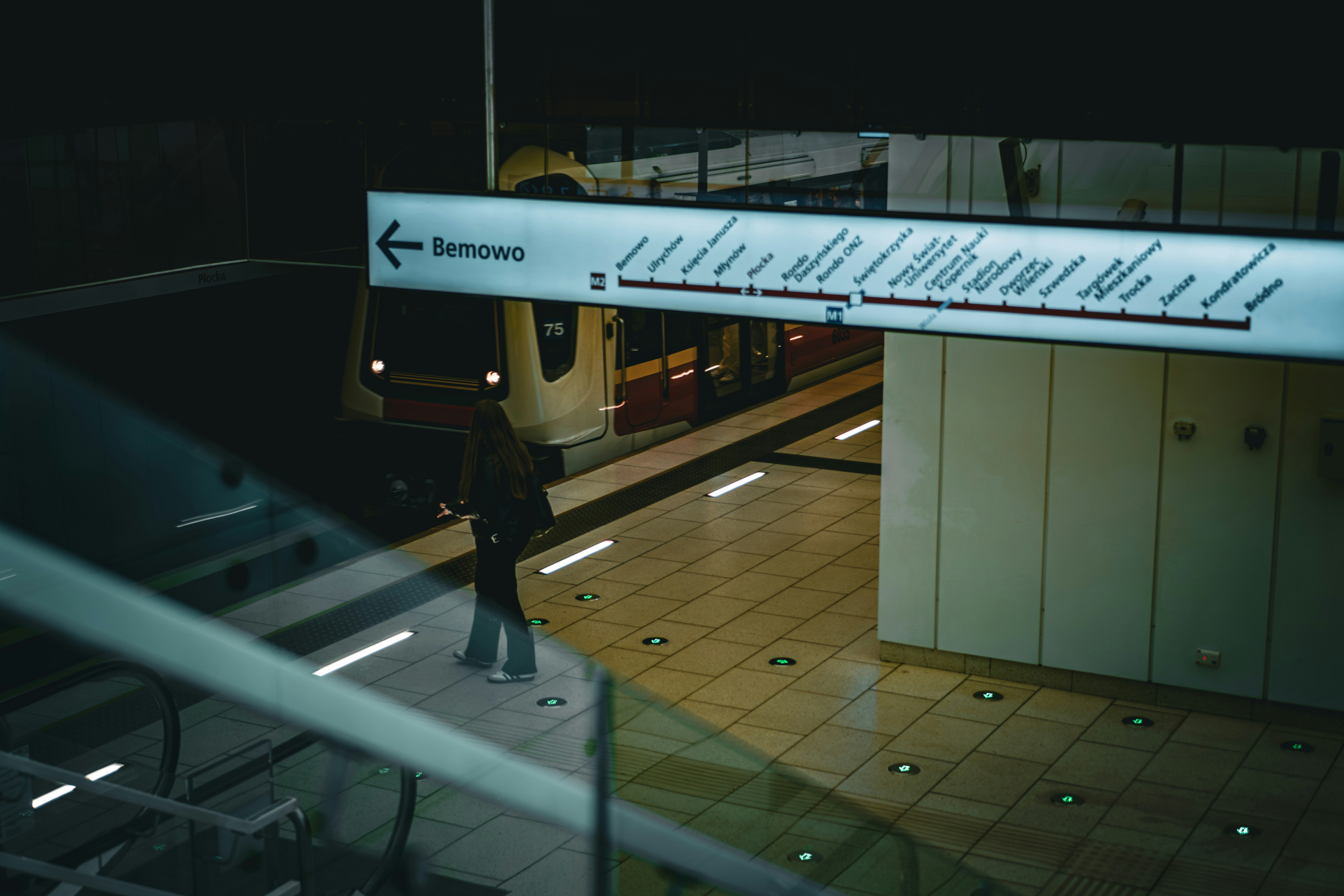 Sombre Train Platform Nook: A Solo Passenger in the Quiet Transit Hall