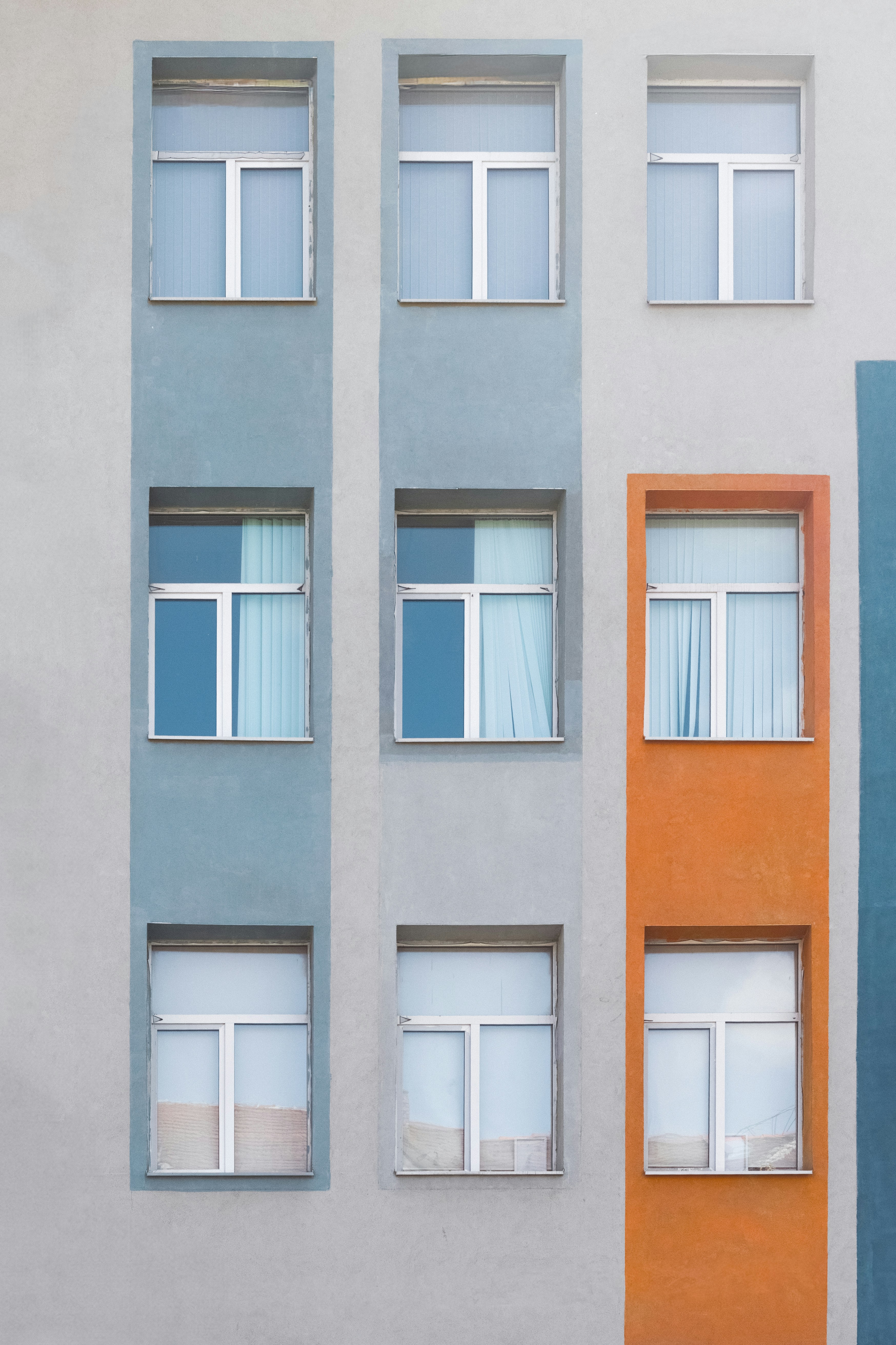 Repeating Facade in Cool Blue and Warm Orange Stripes