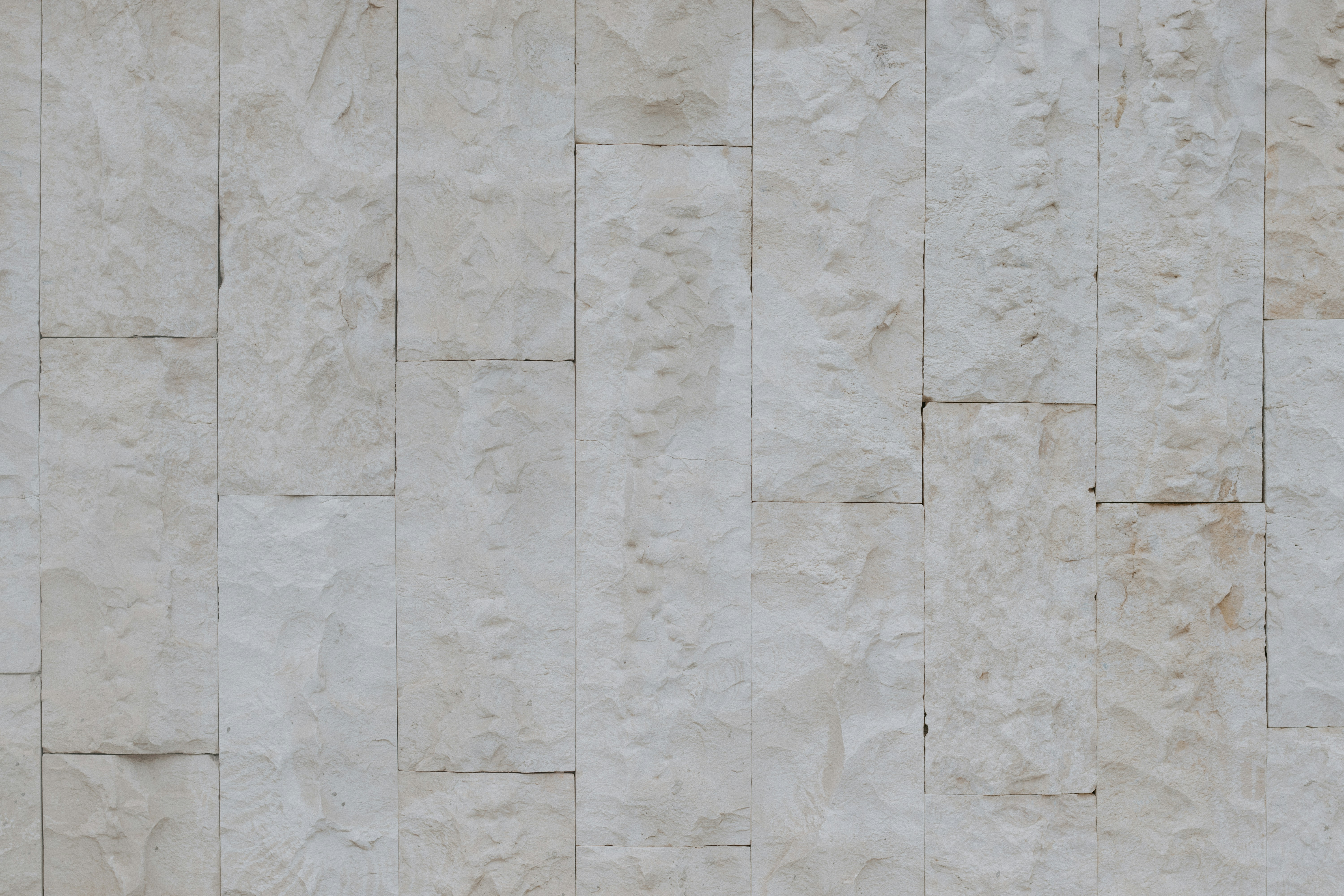 Stone Mosaic Wall: Subtle Texture and Soft Light Across Rectilinear Tiles