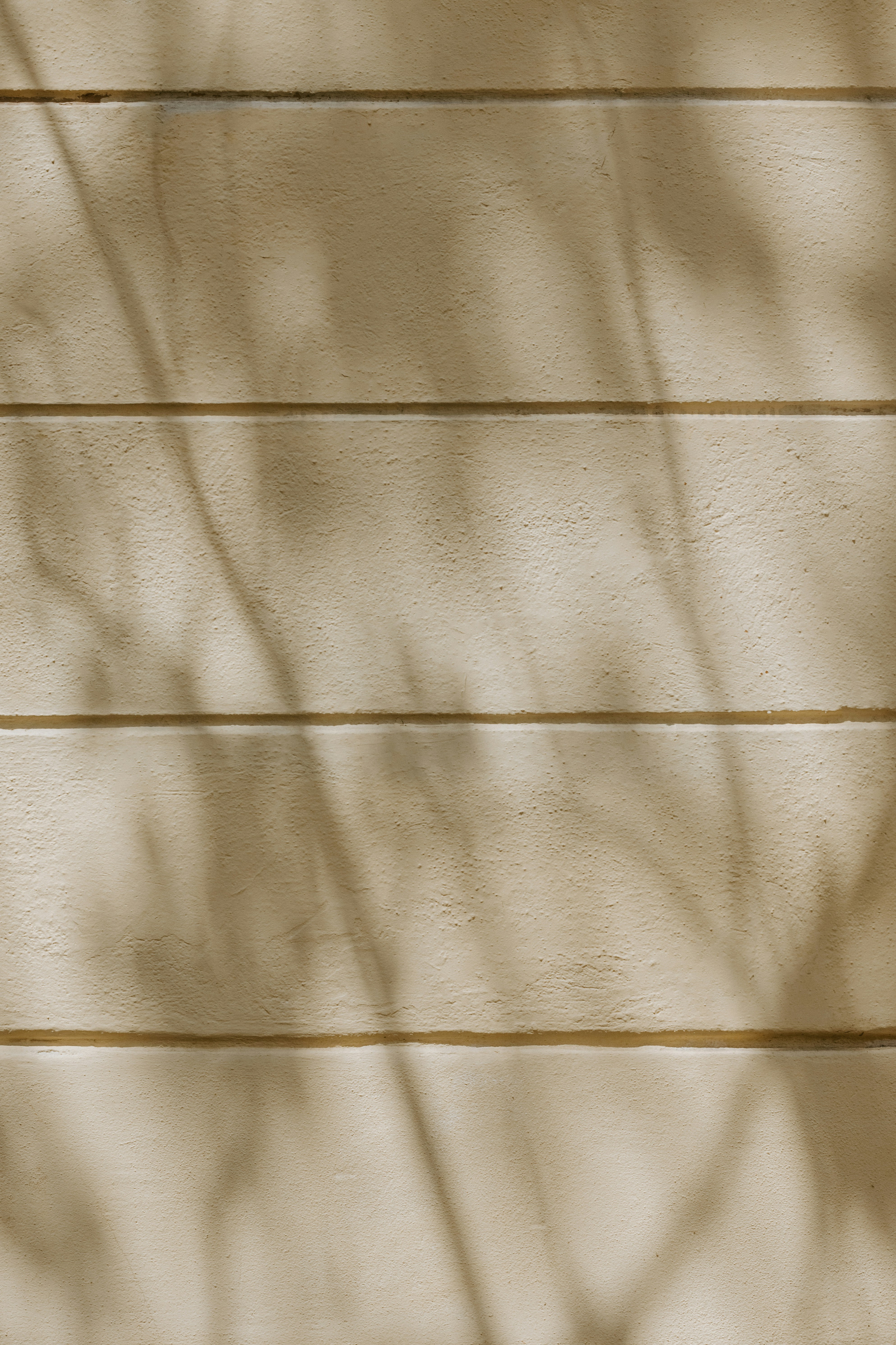 Shadowed Lines on Sand-Colored Wall