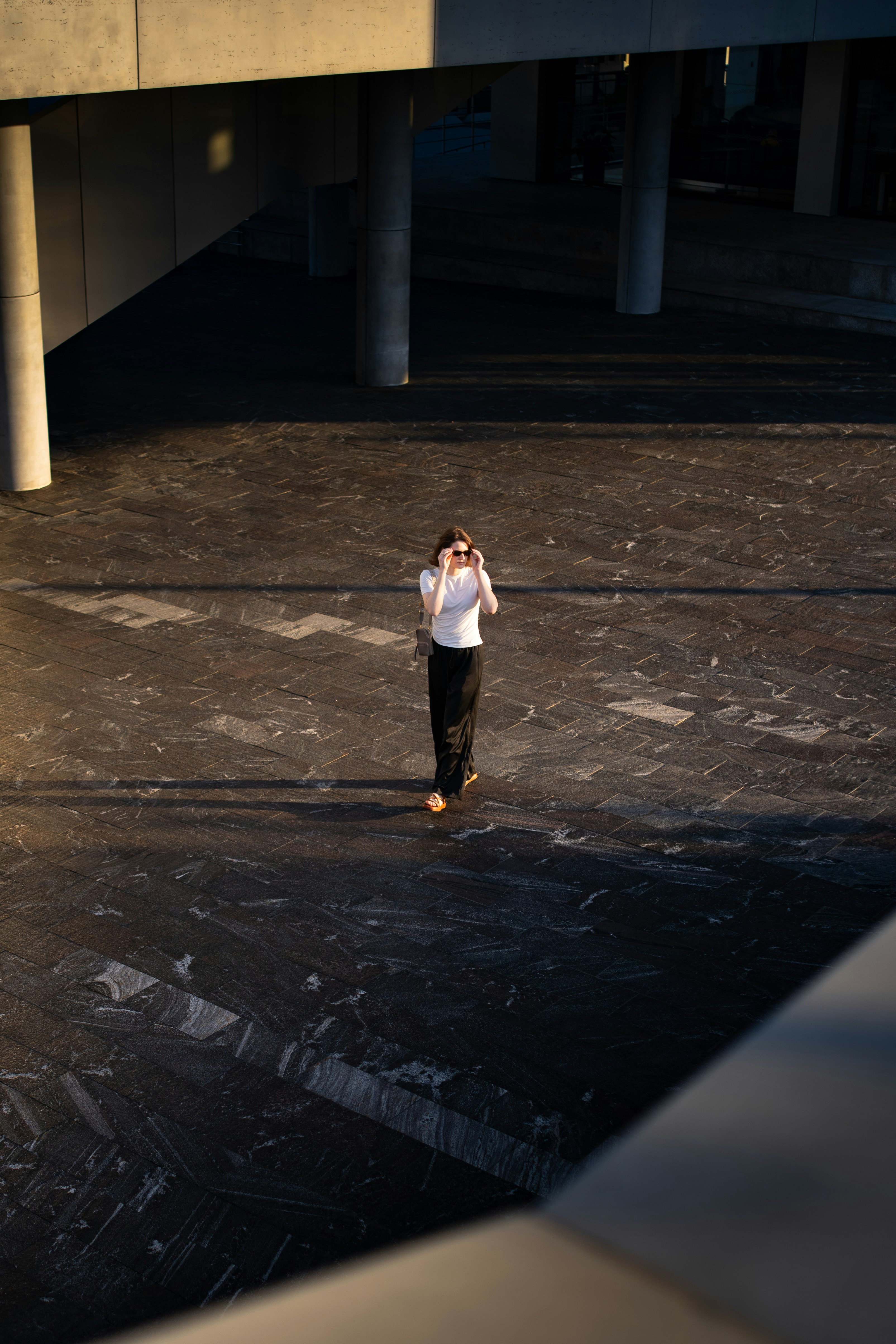 Susurrus of Light: A Solo Figure Under Industrial Spans