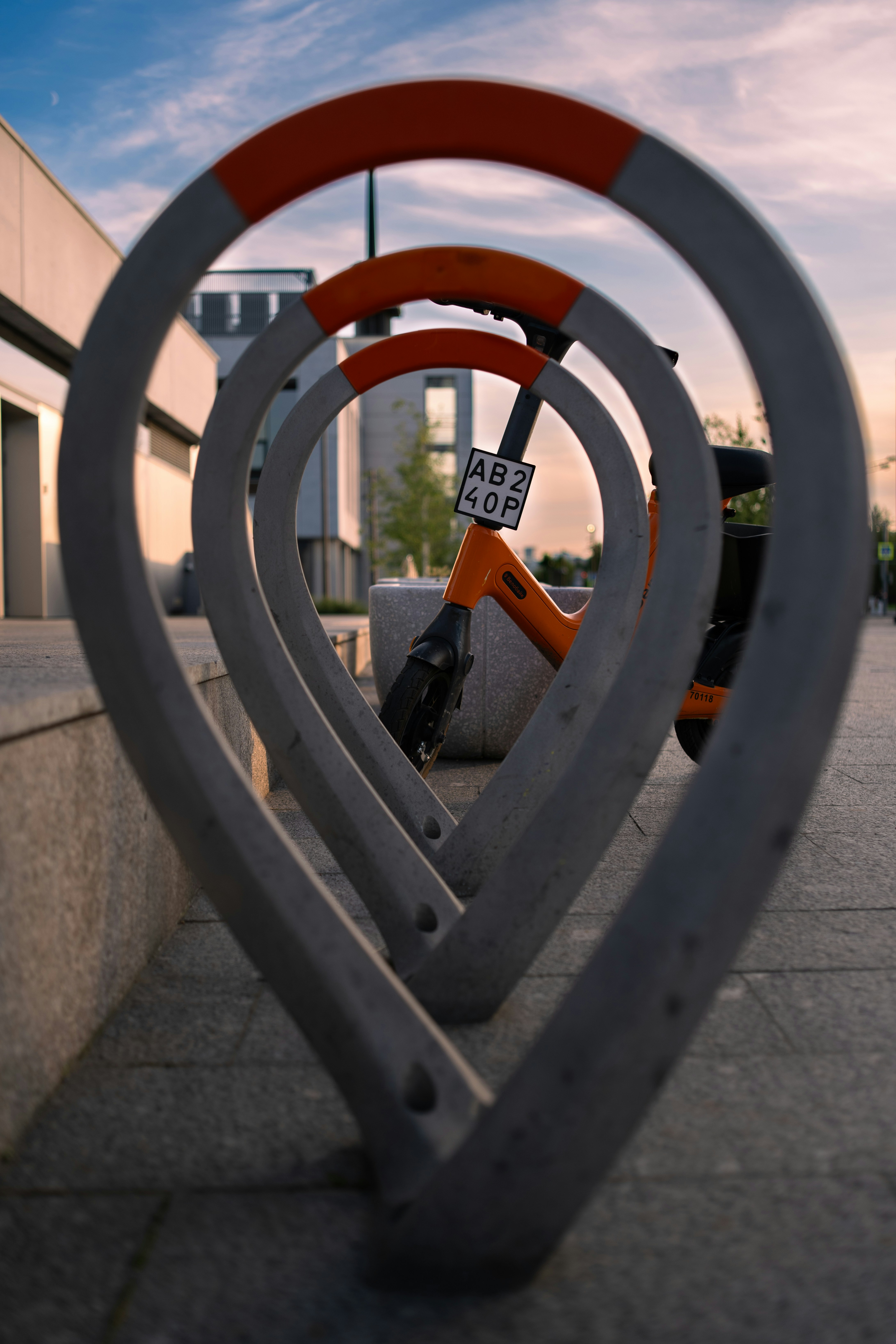 Circular Path: Stripes of Metal Framing Recede Toward a Jurisdiction of Orange