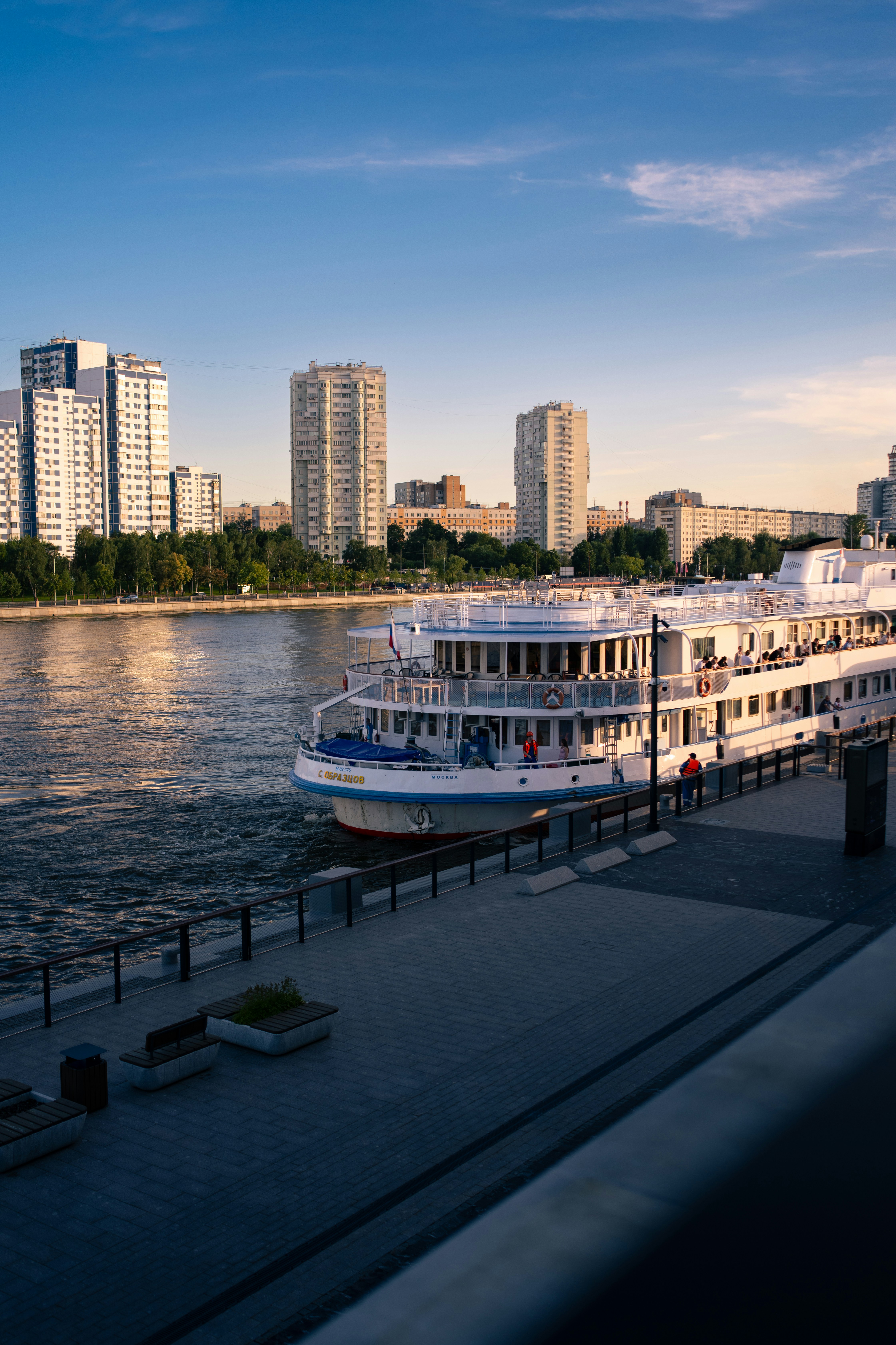 Docked Voyage: Riverfront City Awakens at Sunset