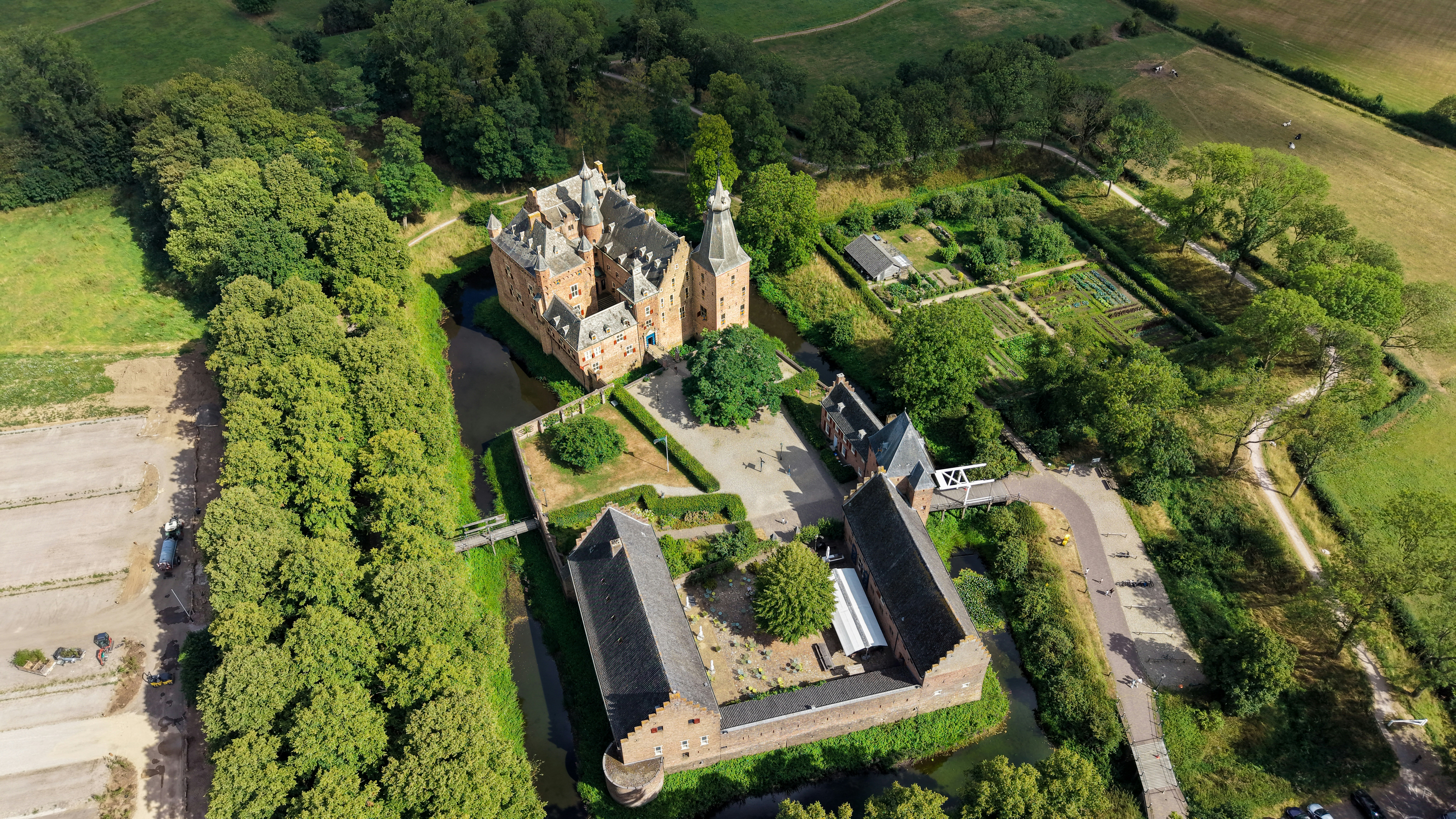 Aerial Culmination: Medieval Stronghold Surrounded by Emerald Fields