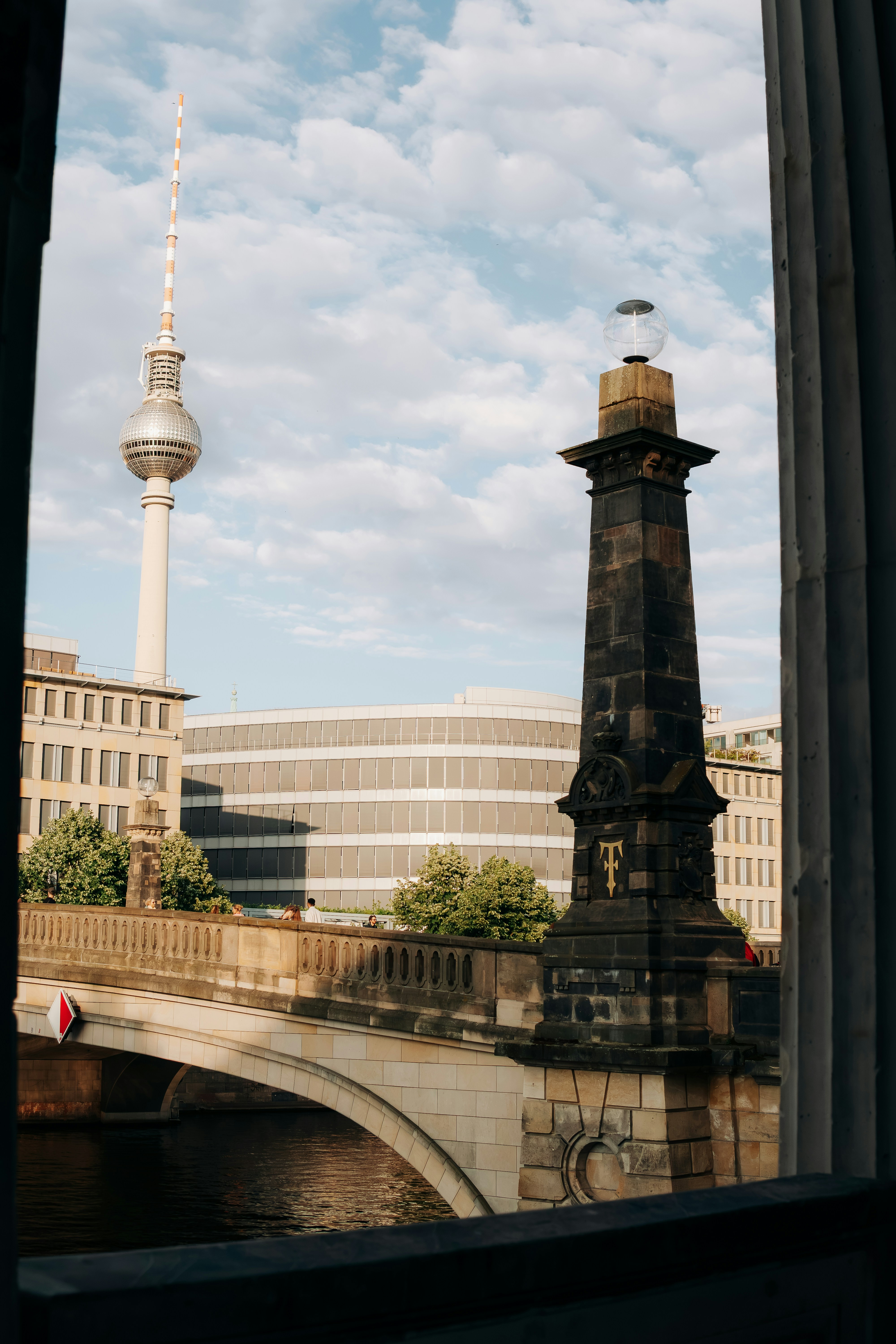Towering Contrast: Modern Skyline Framed by Historic Bridge