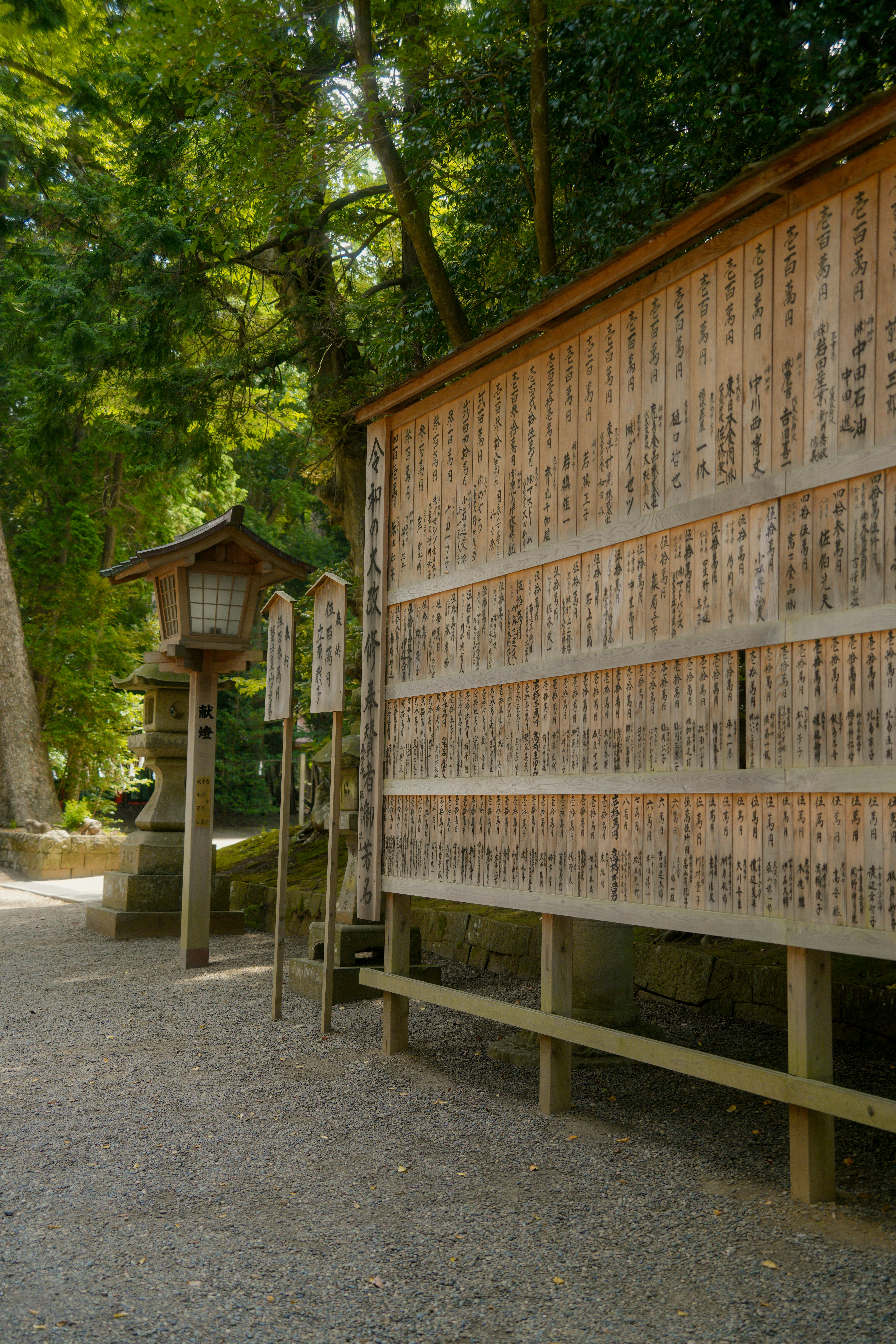 Whispering Tablets: Wooden Plaques in a Shaded Shrine Grove