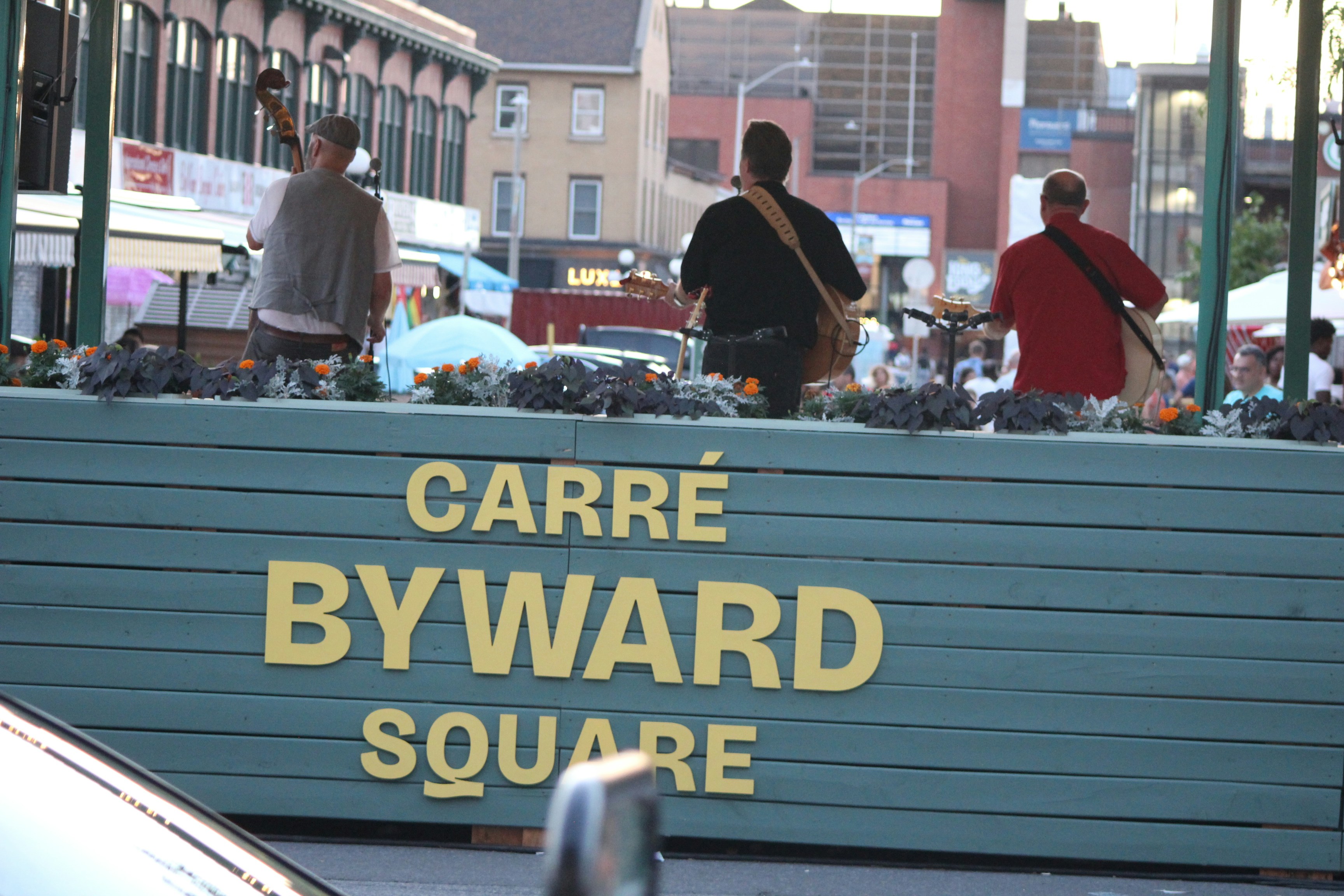 Signage at Carré Byward Square: People Above the Blue Pane