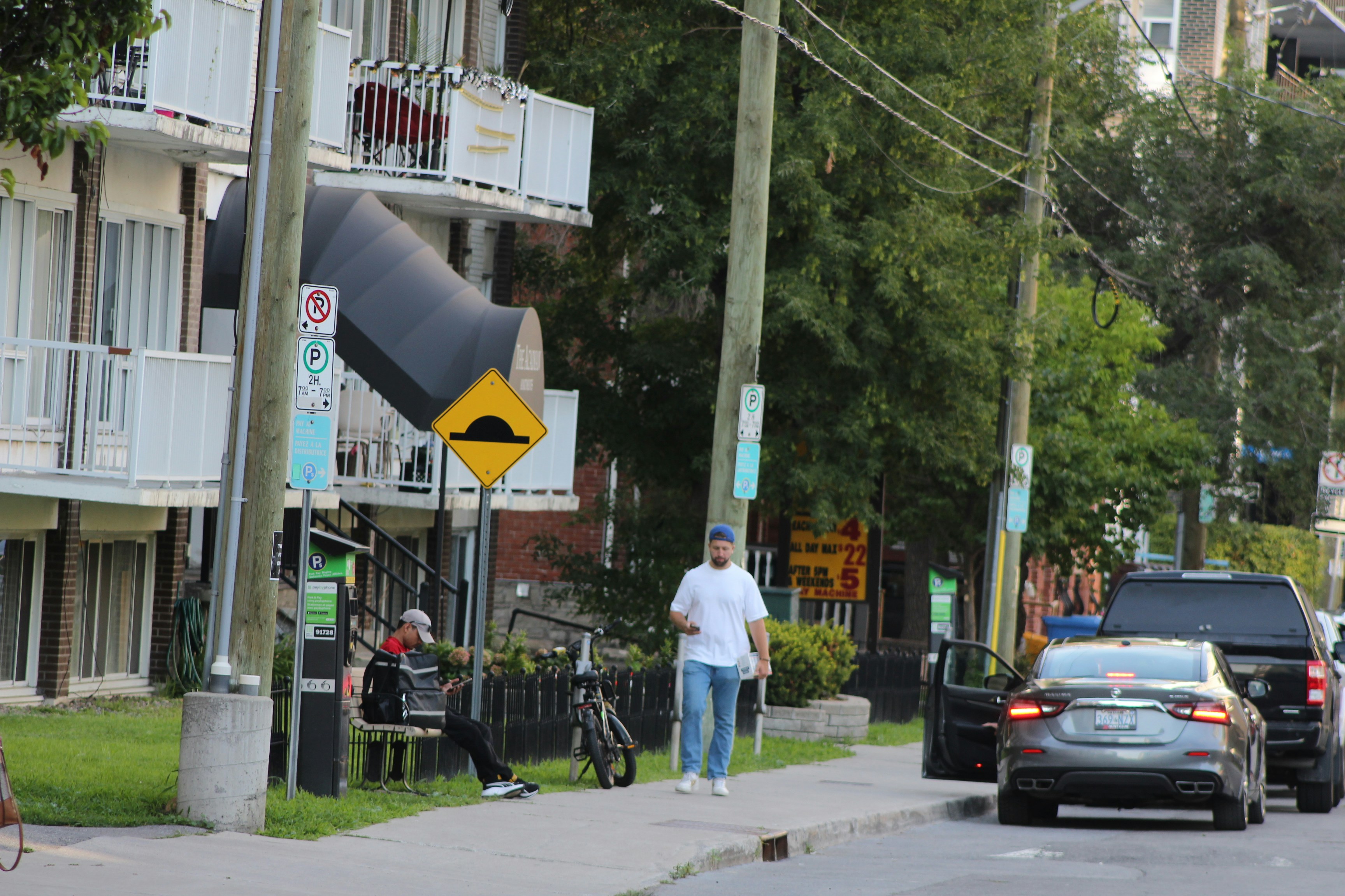 City Sidewalk Portrait: A Quiet Moment by the Storefronts