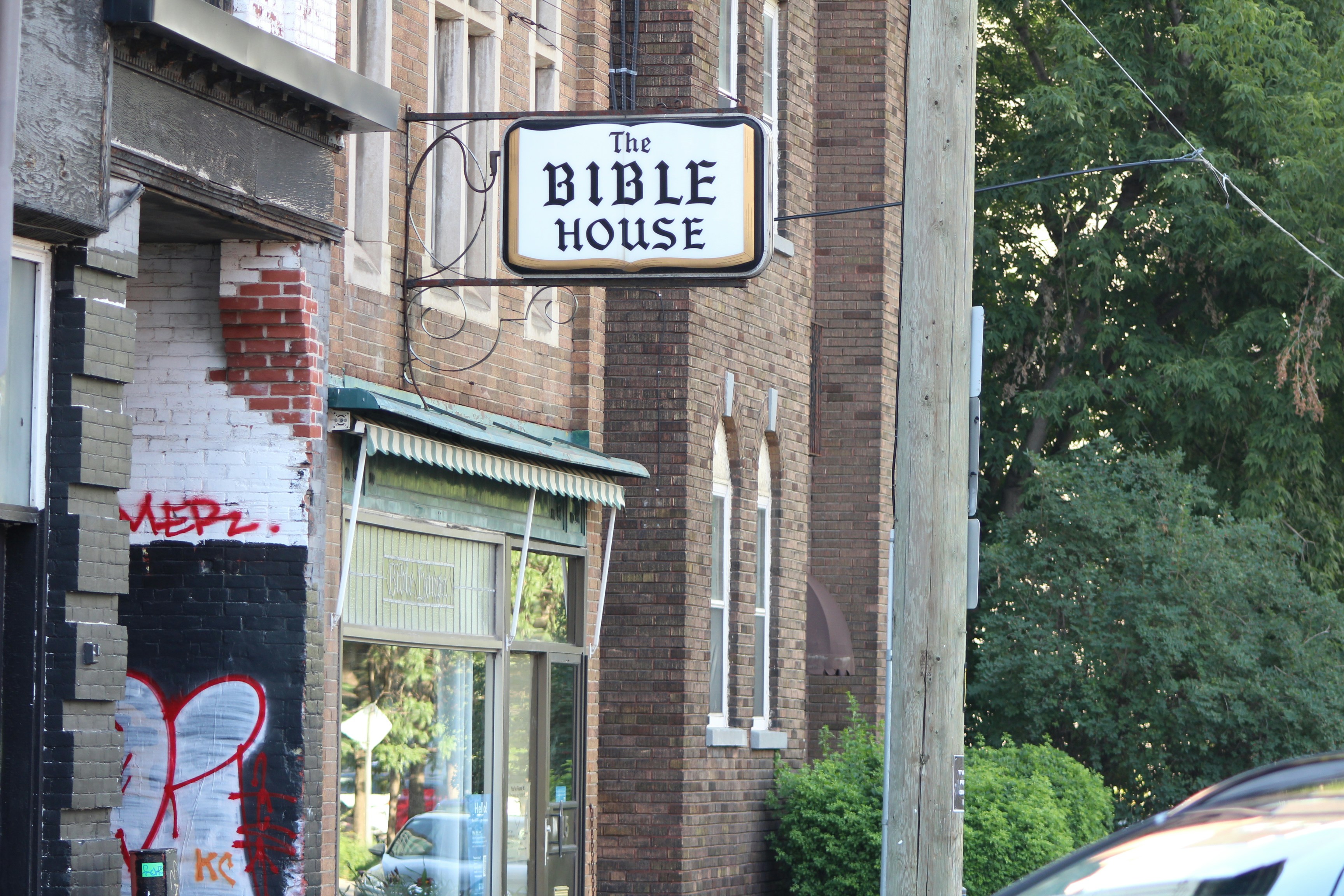 The Bible House Sign Above a Quiet Street Shopfront