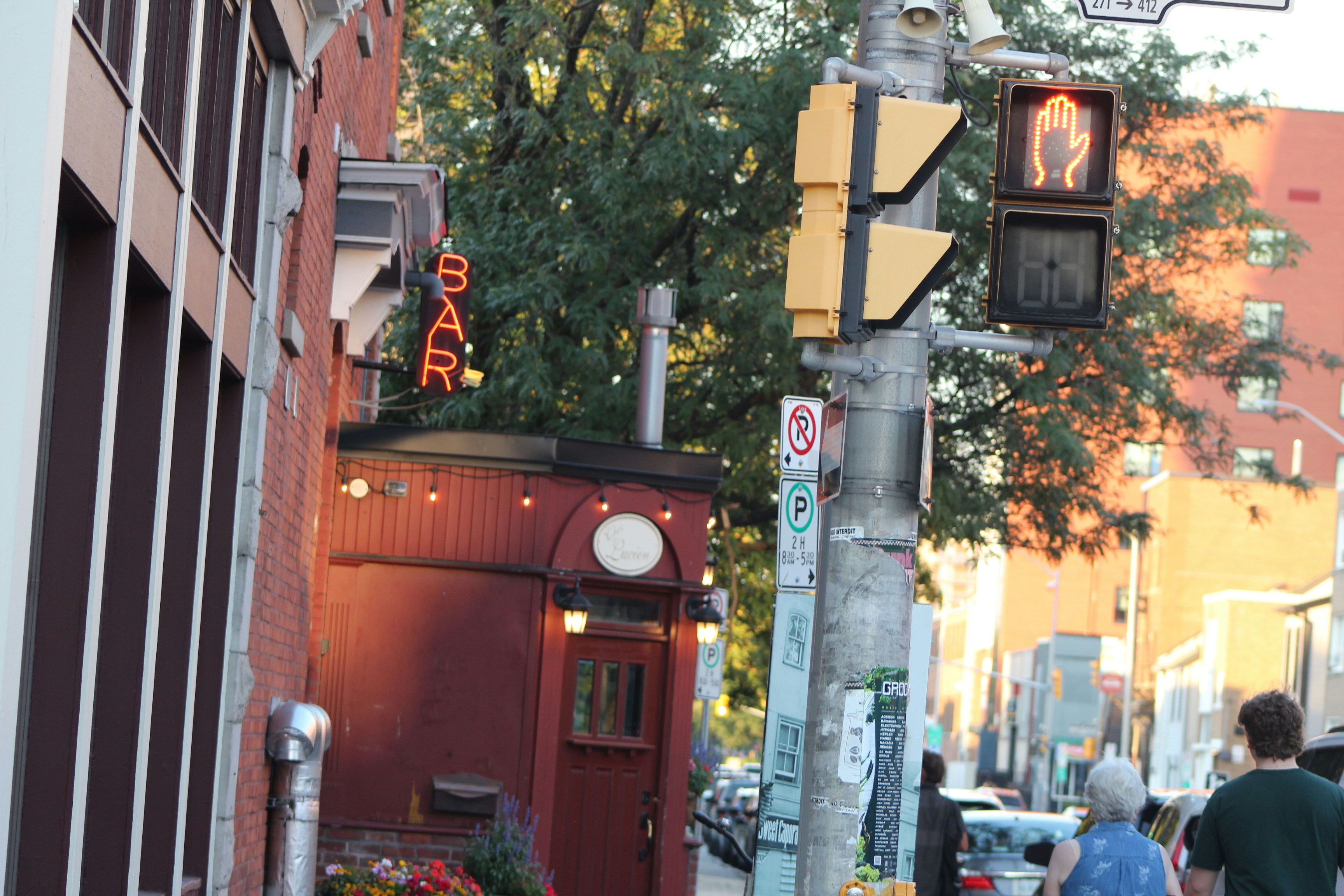 Warm Moonlit Corner: A Red Door Bar Beneath a City Crossing