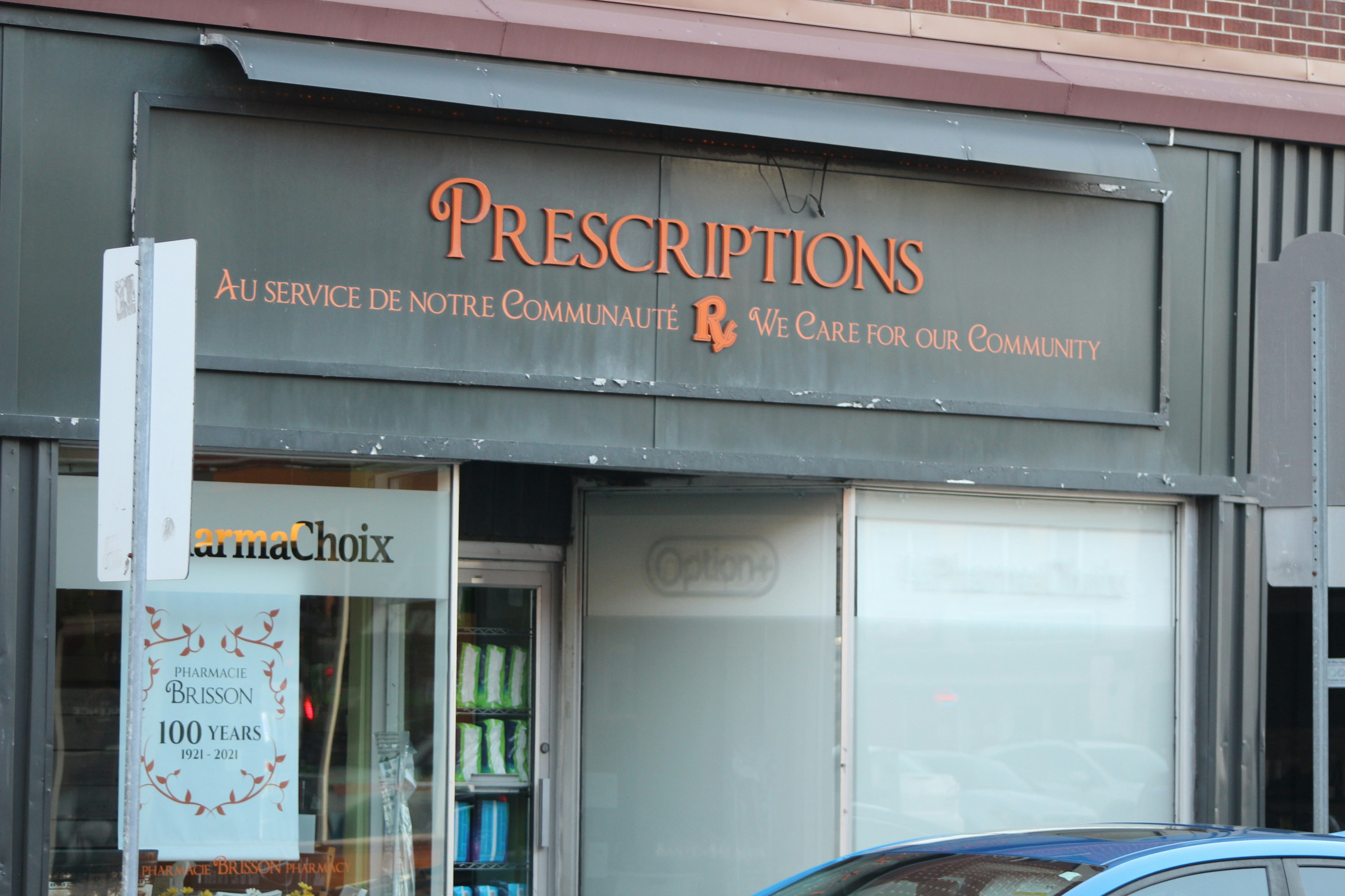 Prescriptions storefront beneath a weathered sign