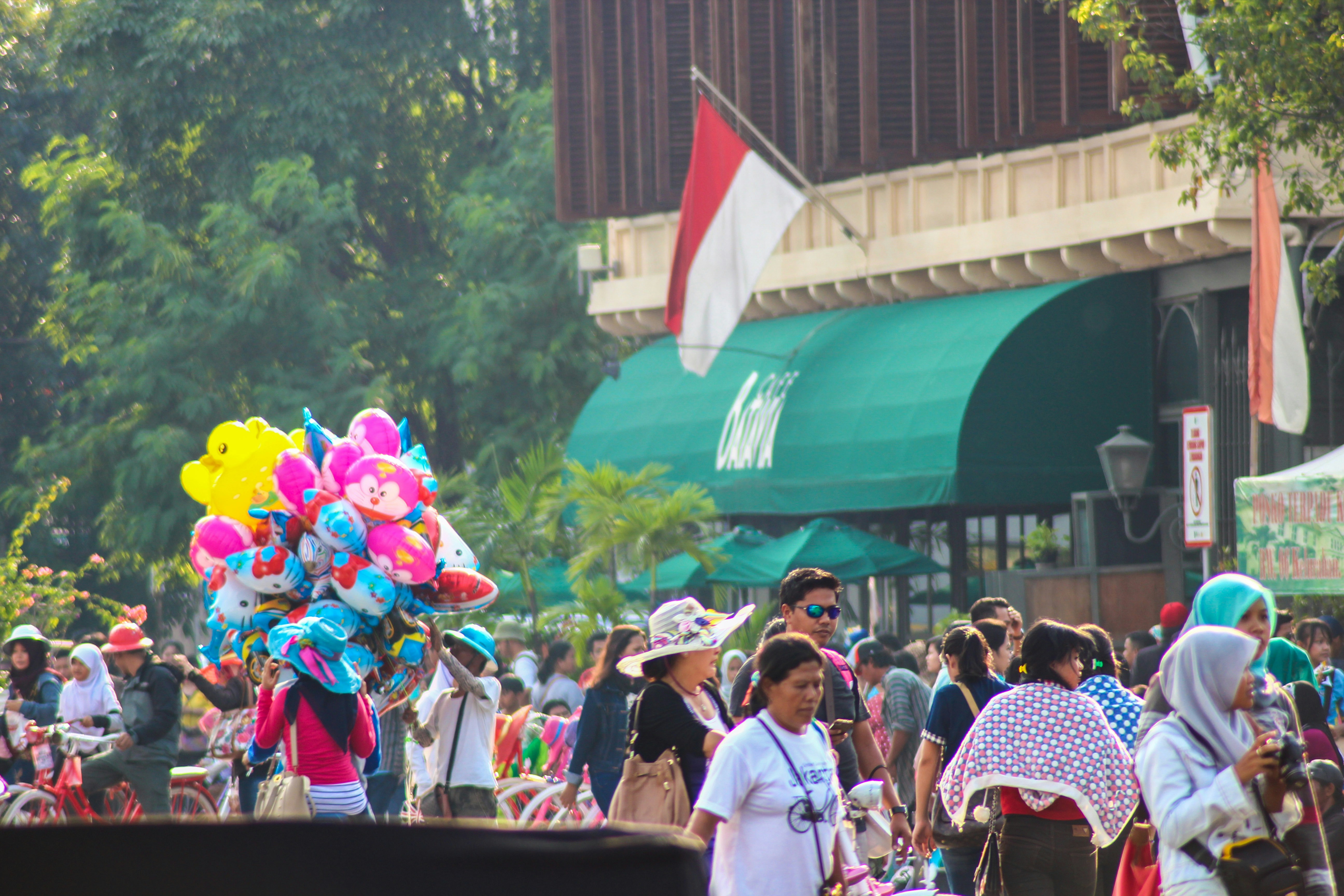 Crowd Carnival Under a Green Canopy