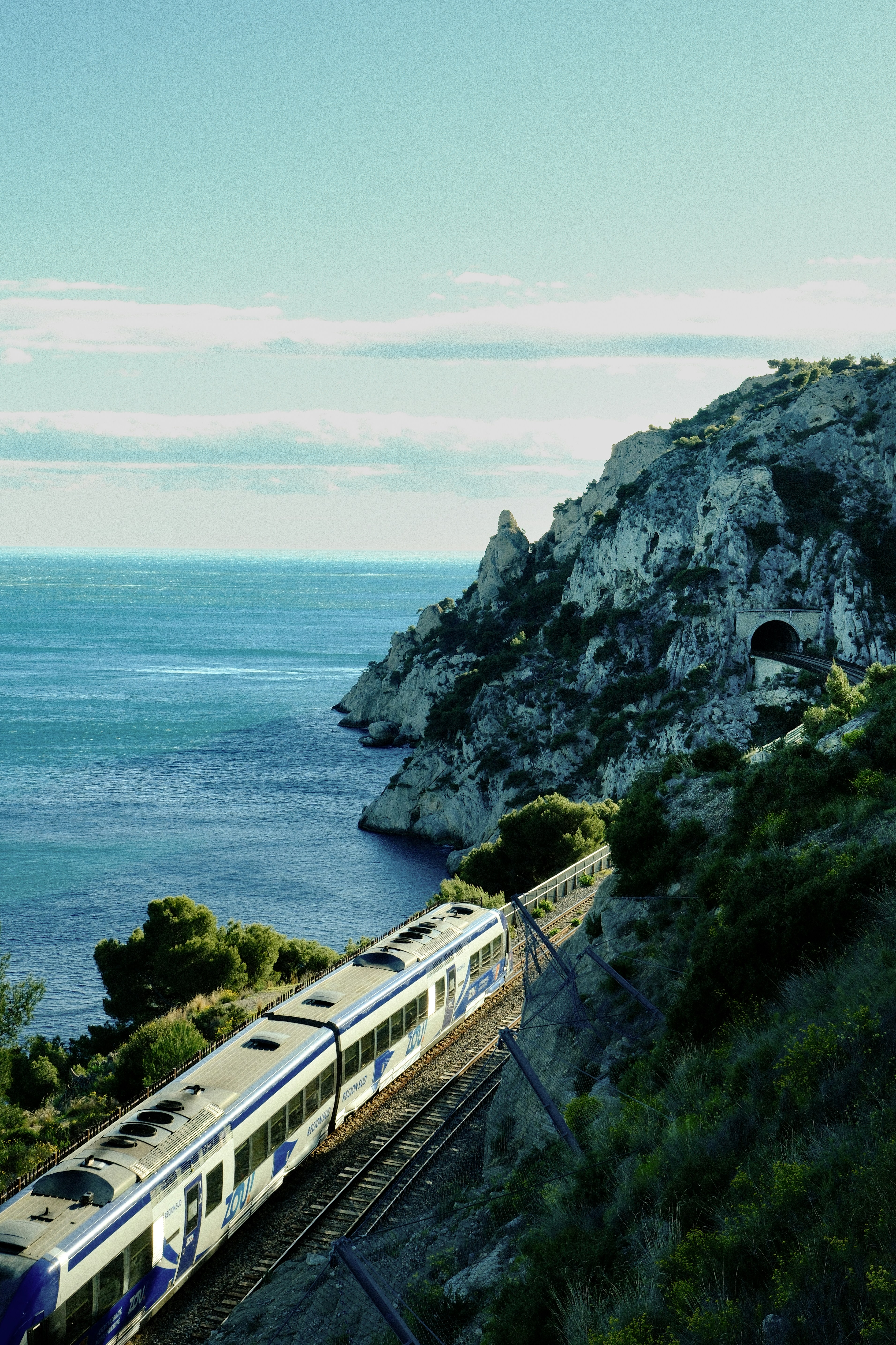 Coastal Rail Curl: Train Wends Along Cliffside Route