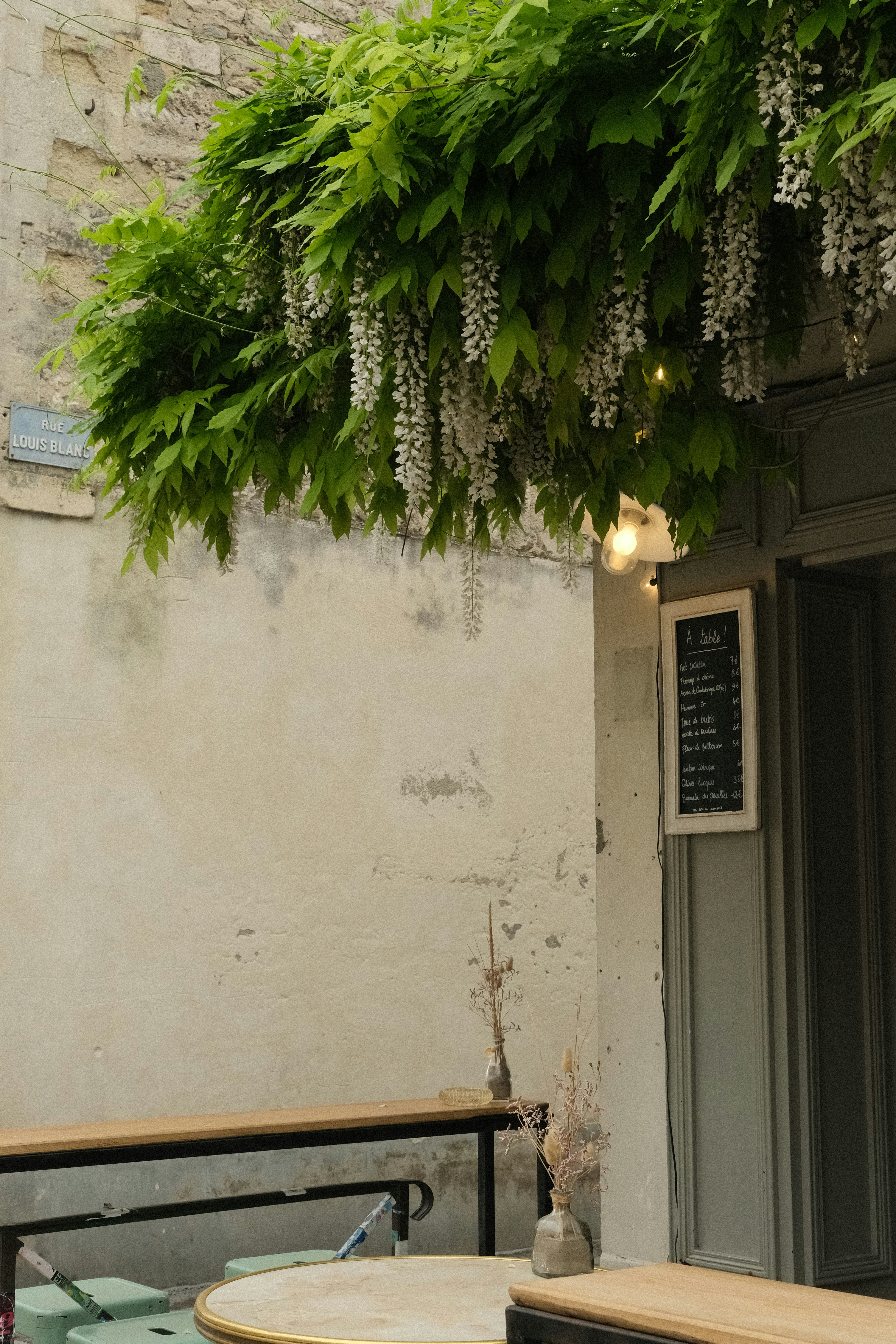 Watched Terrace: Dusk Light Under a Cascade of White Flowers