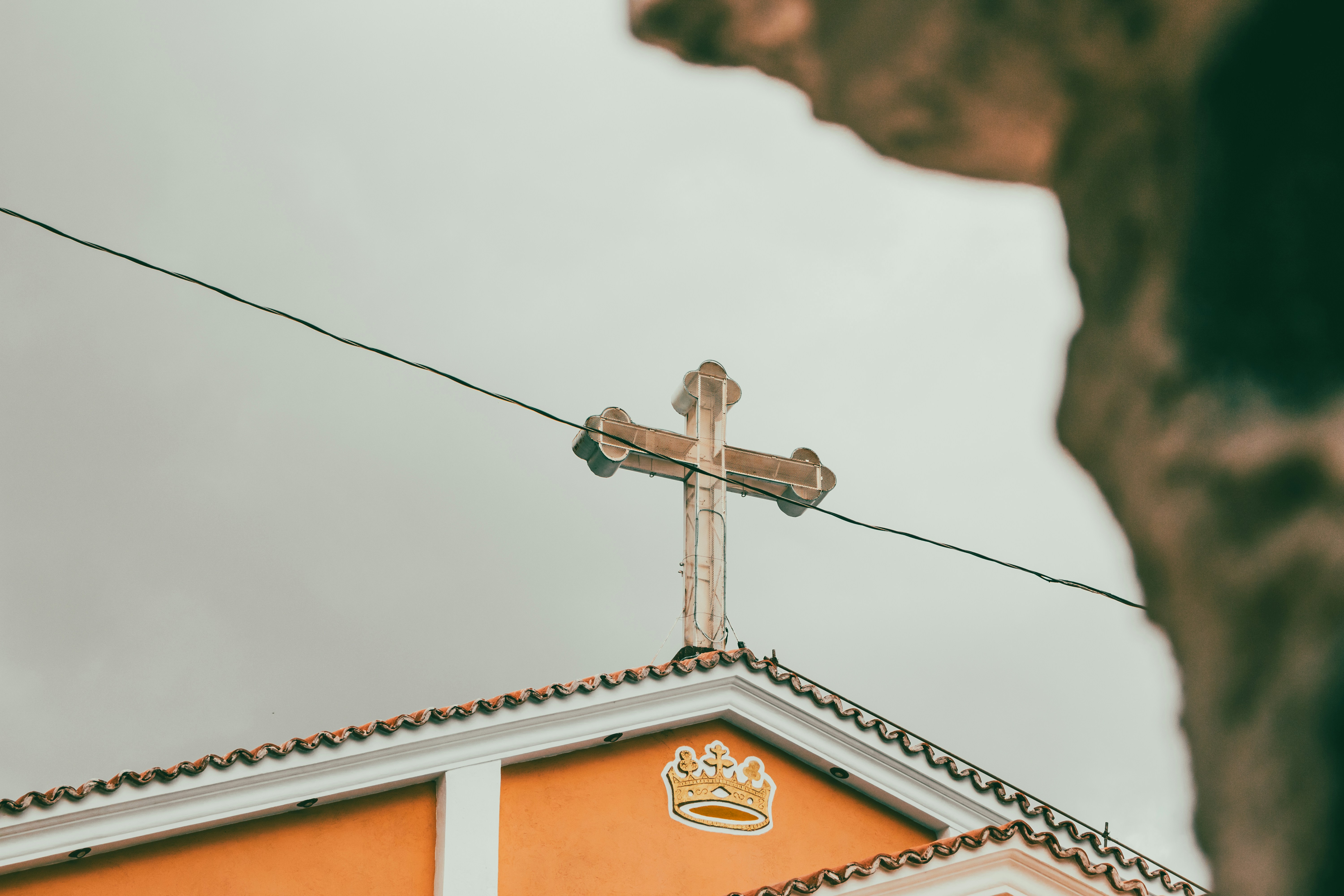 Crested Roofline beneath a Floating Cable