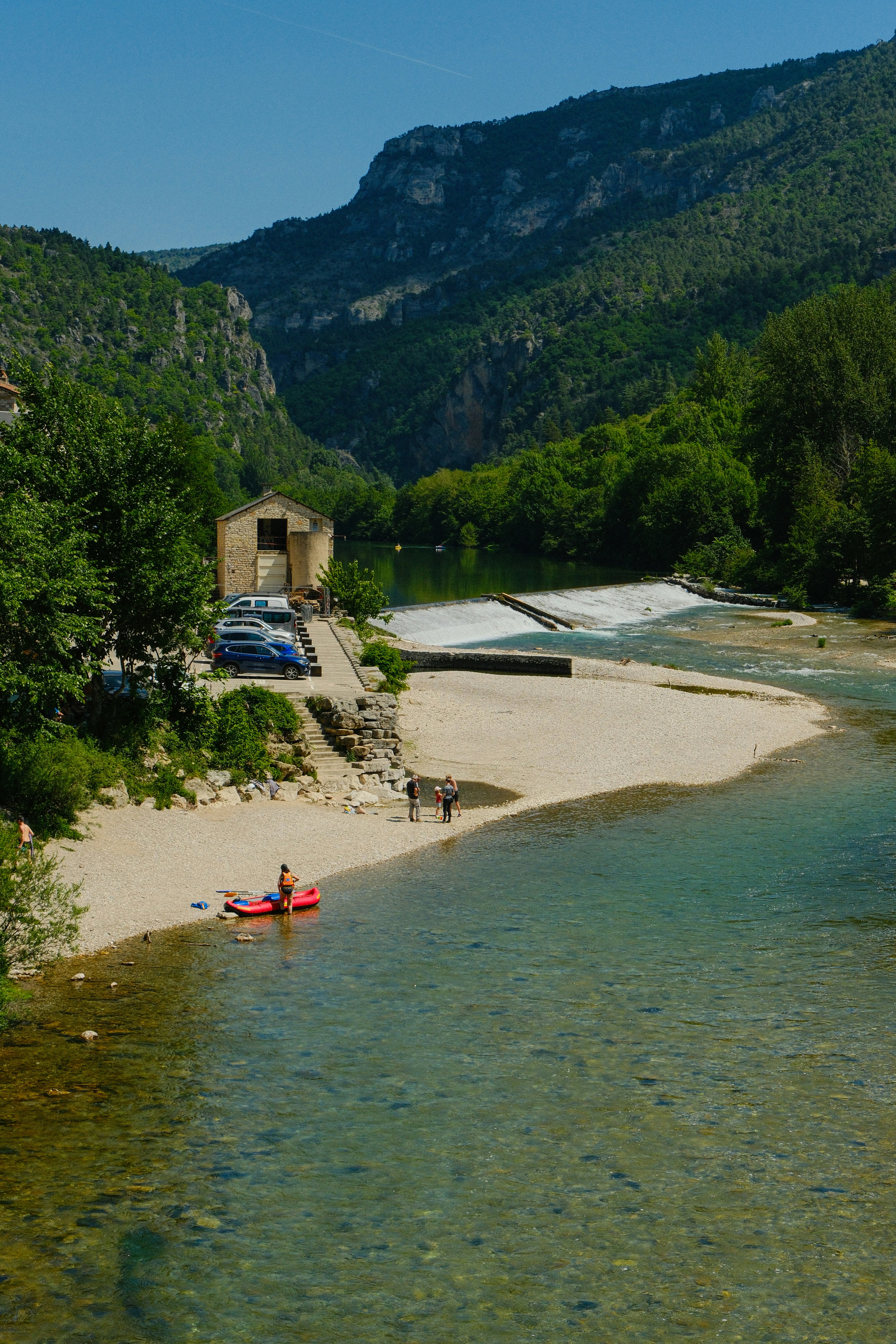 Riverside Rendezvous: A Cedar-green Gorge Under Clear Summer Light