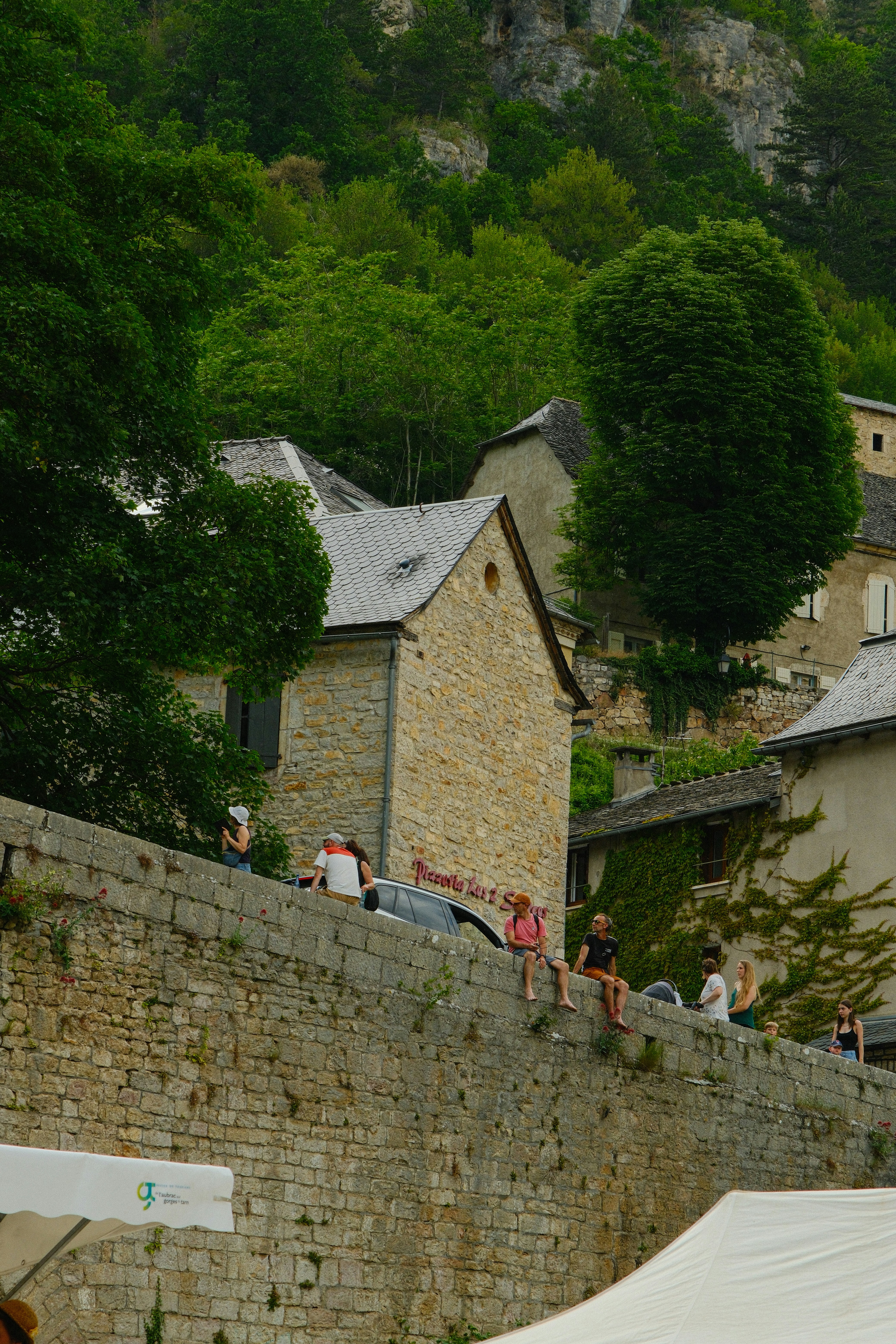 Ridge-side village scenes: stone houses and visitors along the ancient terrace