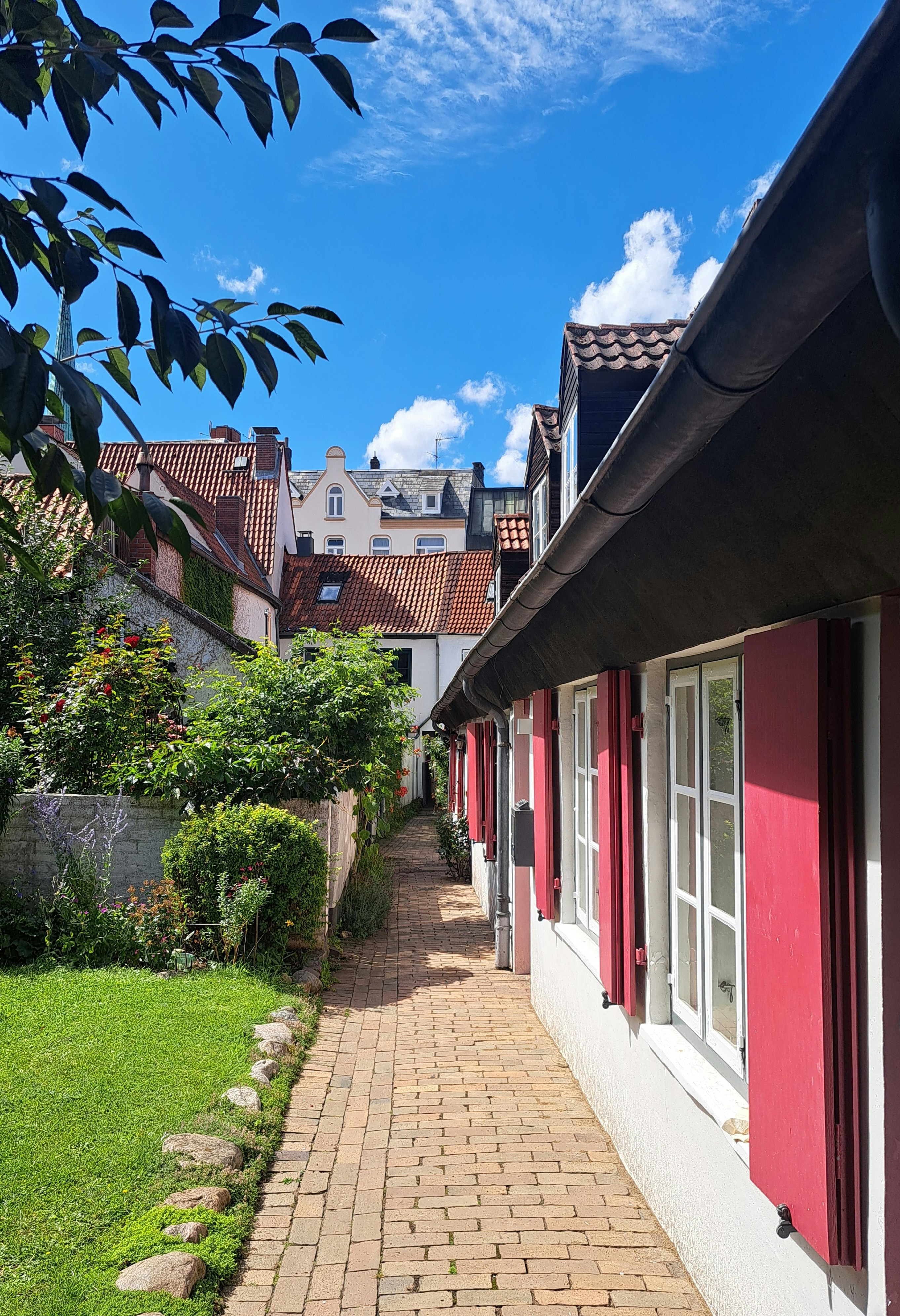 Cobbled Pathway Between Sunny Townhouses