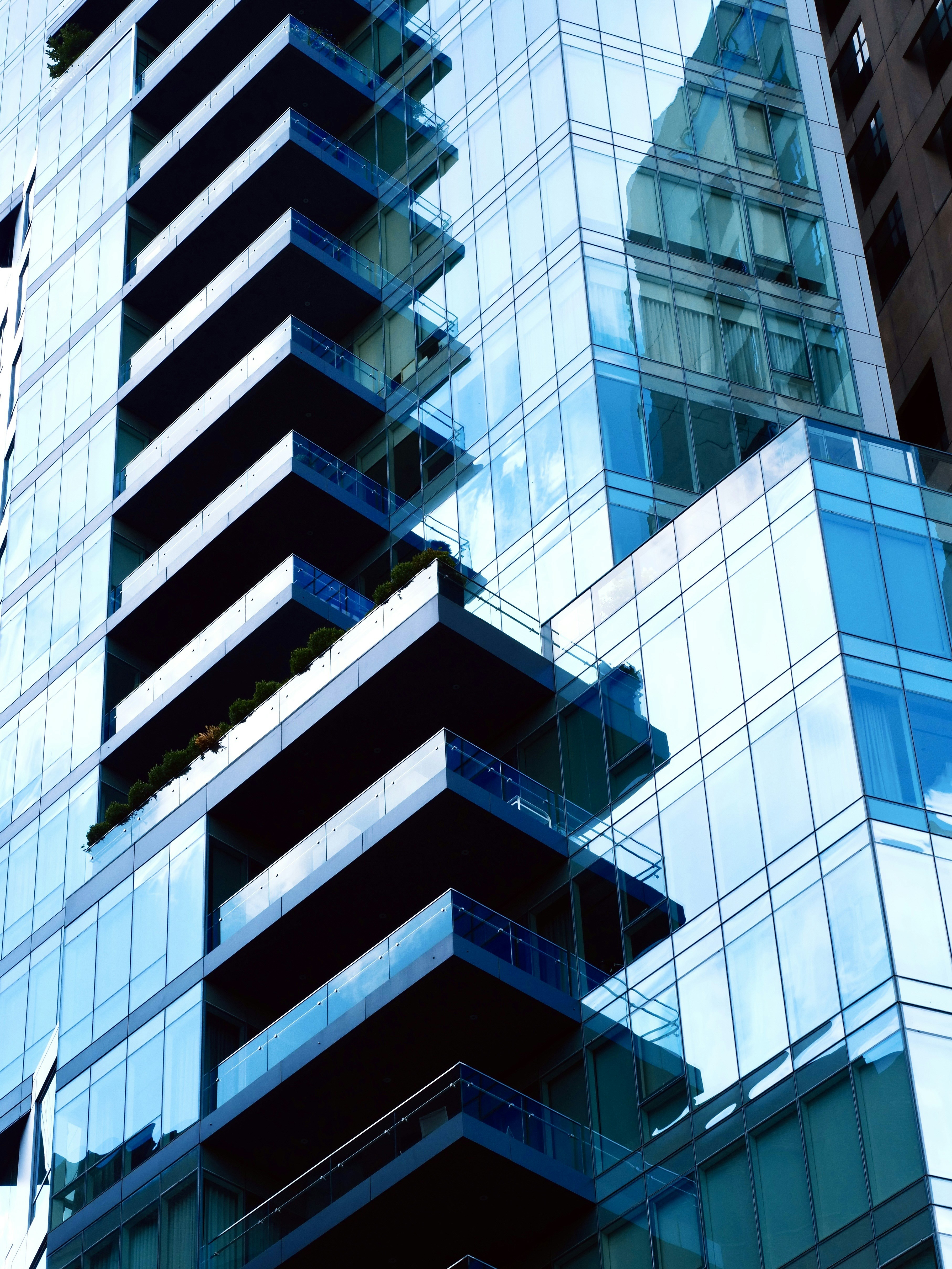 Vertical Glass Dreams: A Faceted Cityscape of Balconies and Reflections