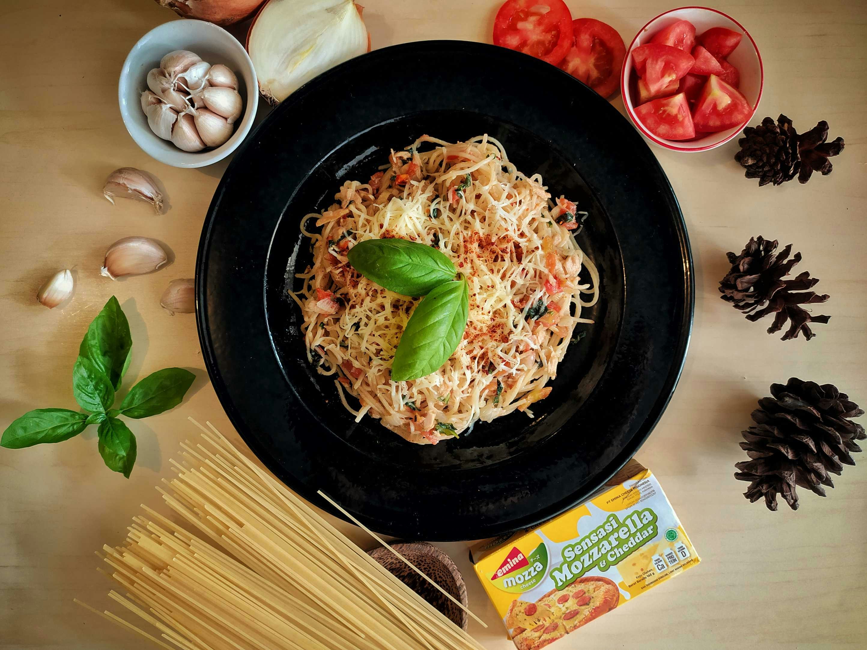 Herbed spaghetti centerpiece framed by pantry accents