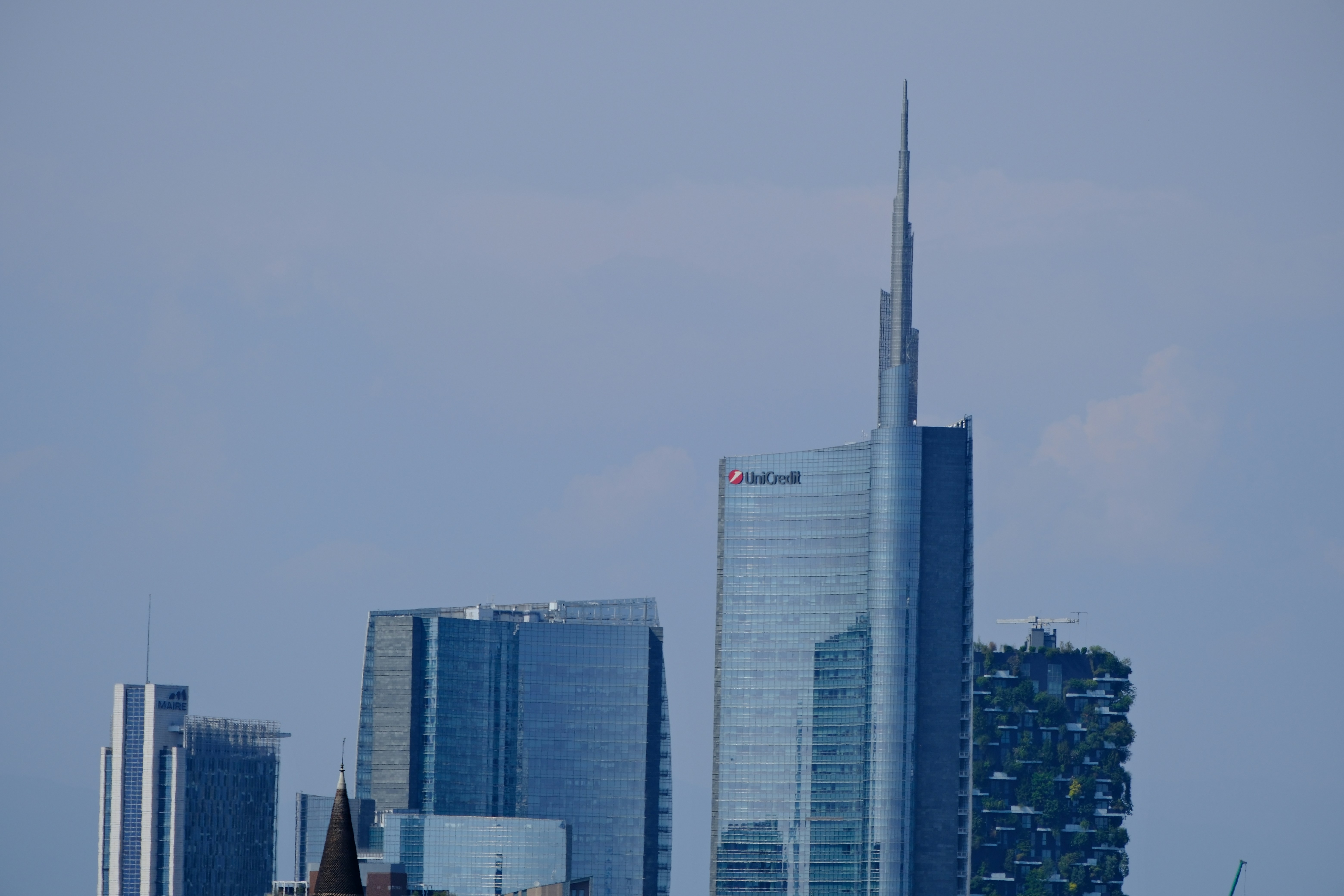 Skyline's Crown: The Burj-like Tower Pierces Pale Clouds