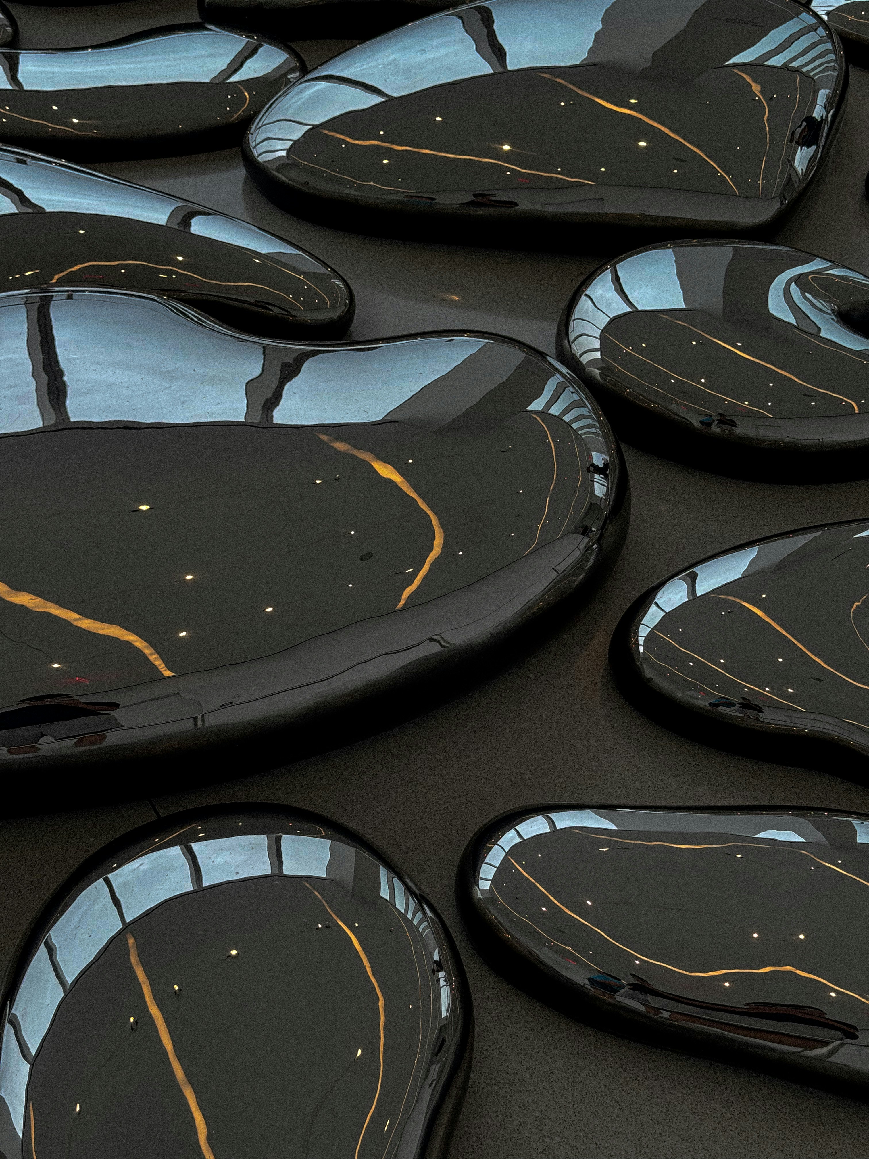 Glossy Pebbles: Reflections on a Dark Surface