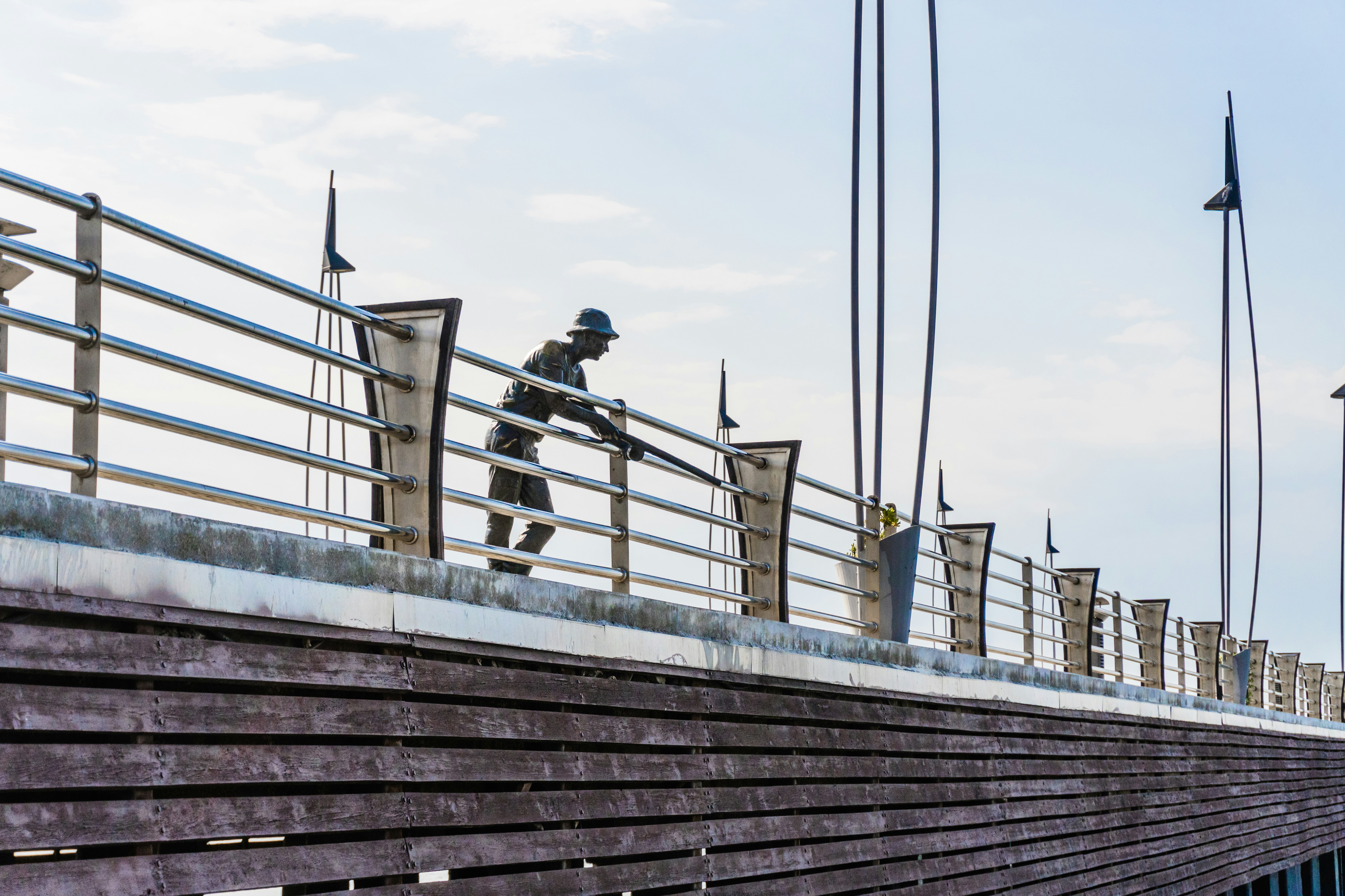 Figure on a Maritime Preserve: A Handler Traverses a Railing at Distant Horizon