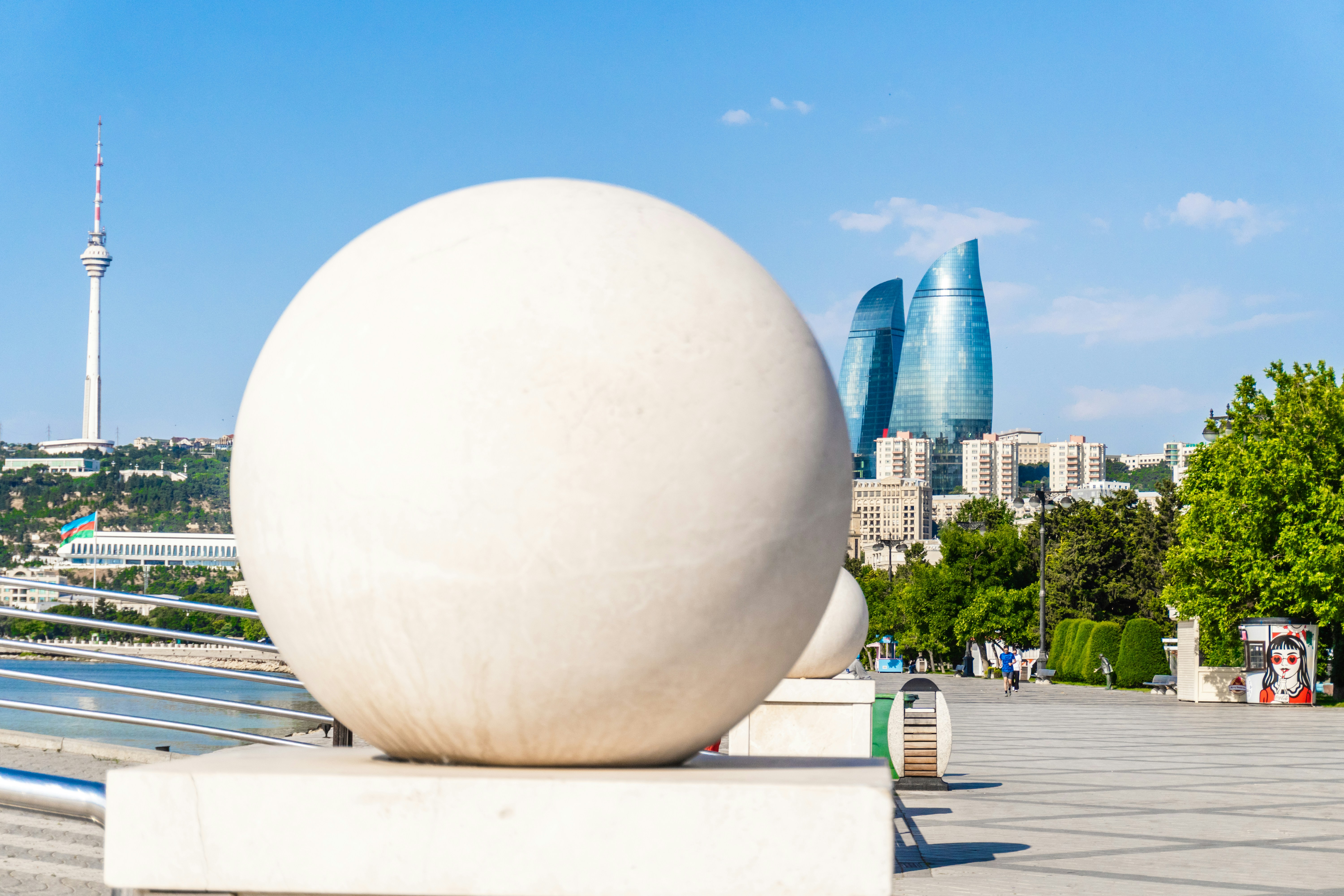 Giant Sphere on a Quiet Promenade with City Skyline