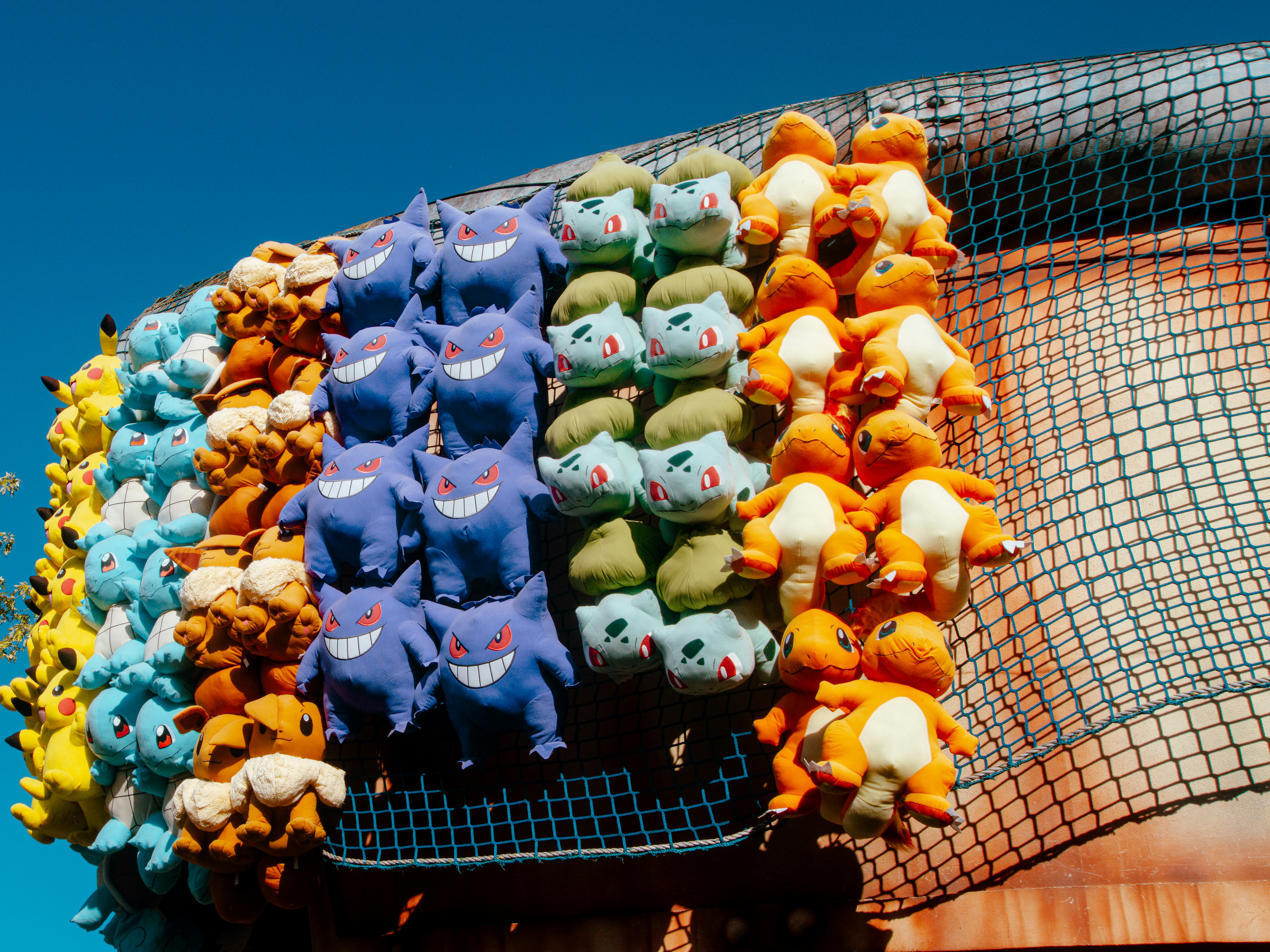 Colorful Plush Pokémon Parade on a Net
