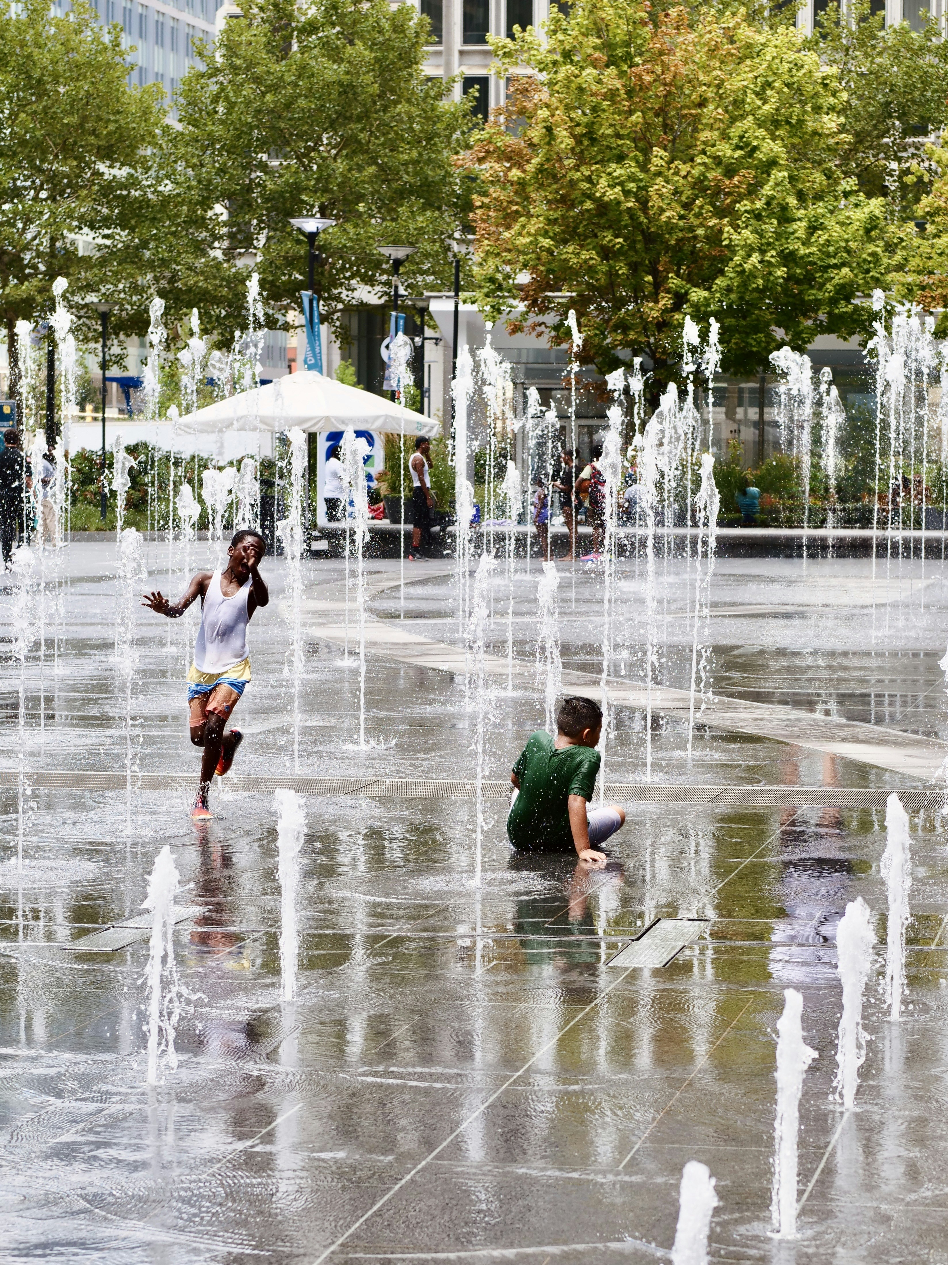 Kids at Play Beneath a Fount of Sprays in an Urban Plaza