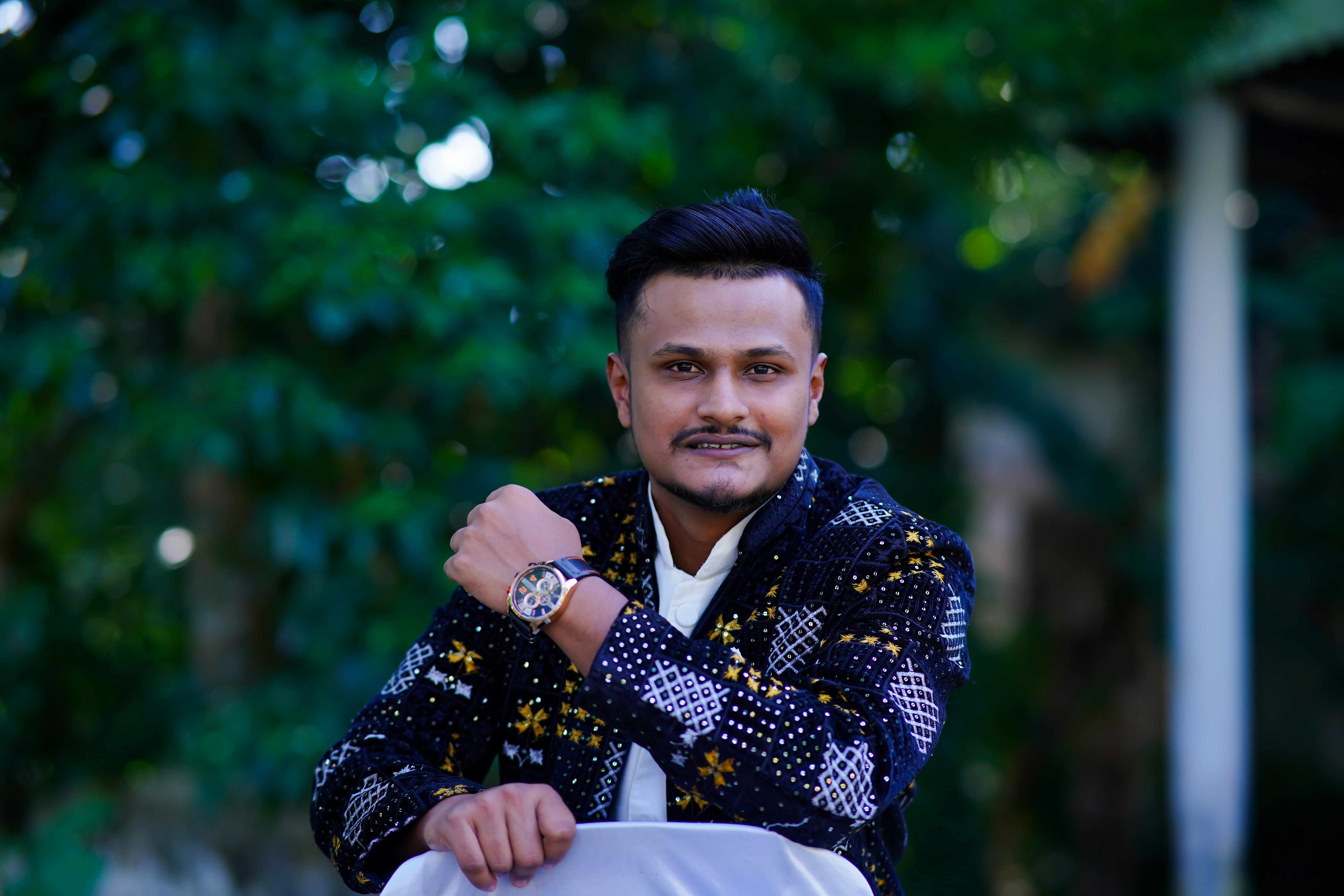 Confident Portrait Beneath a Canopy of Green