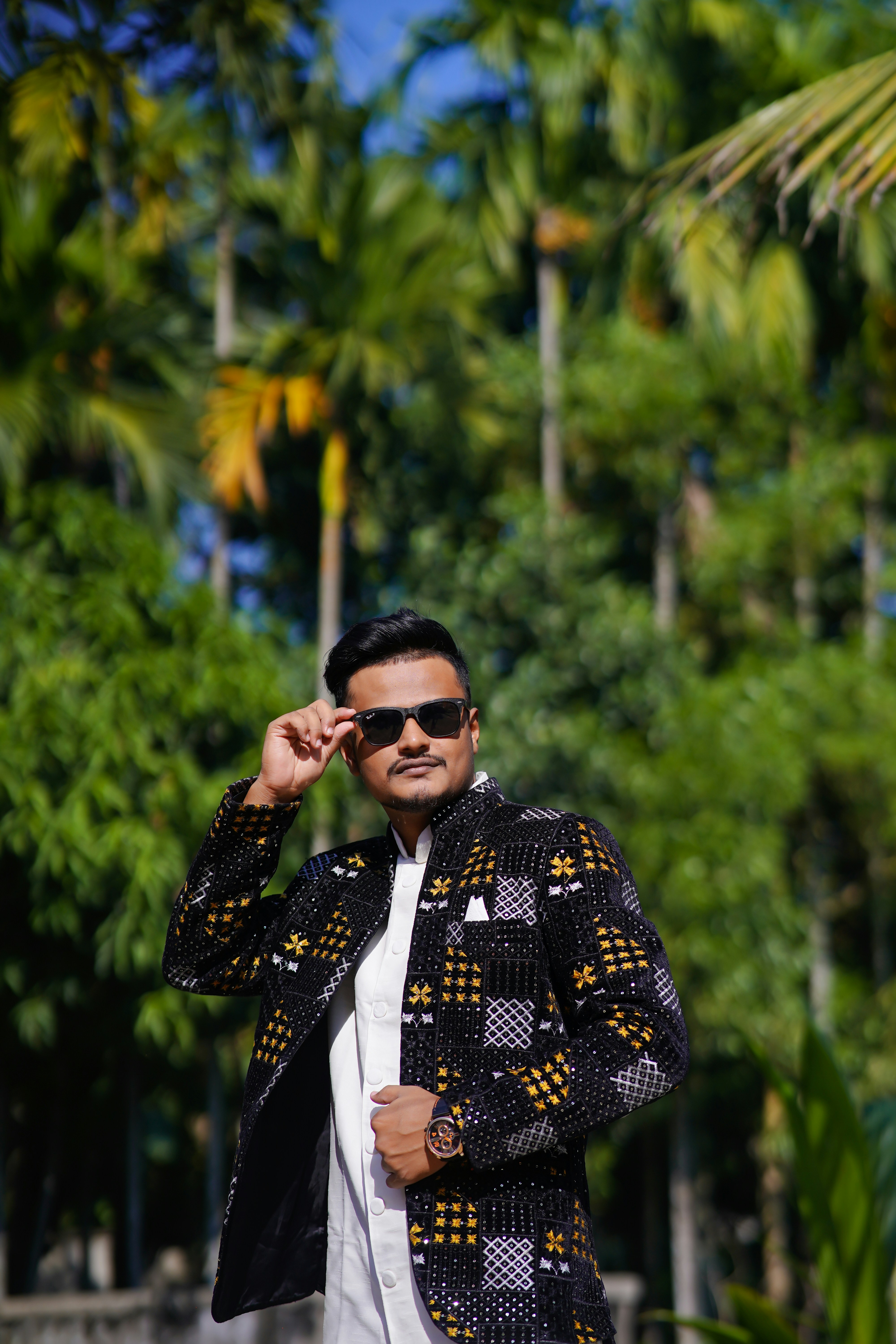 Portrait in Pattern: A Dapper Moment Amid Verdant Backdrop