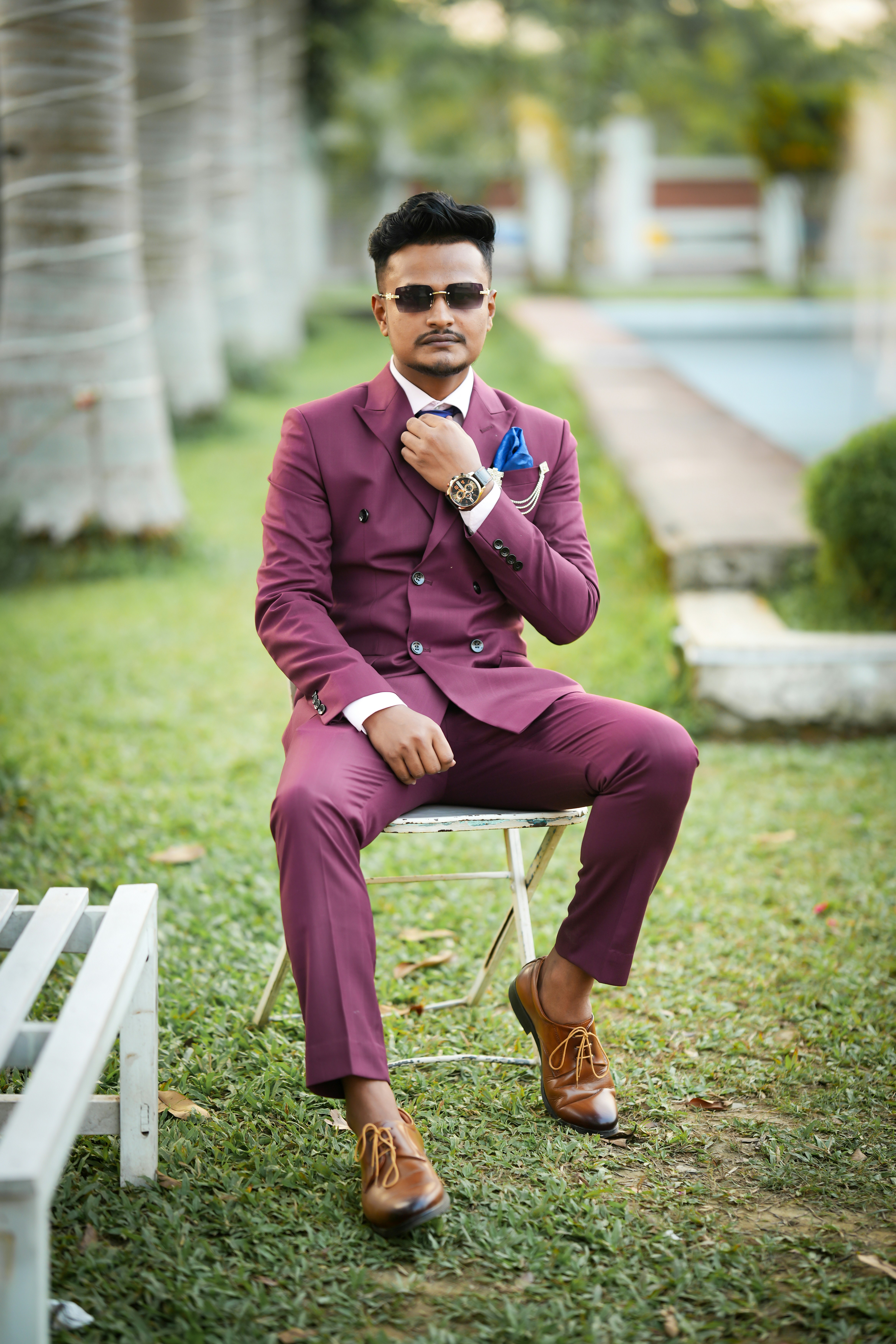 Crimson Suit, Confident Focus: A Stylistic Portrait in the Garden