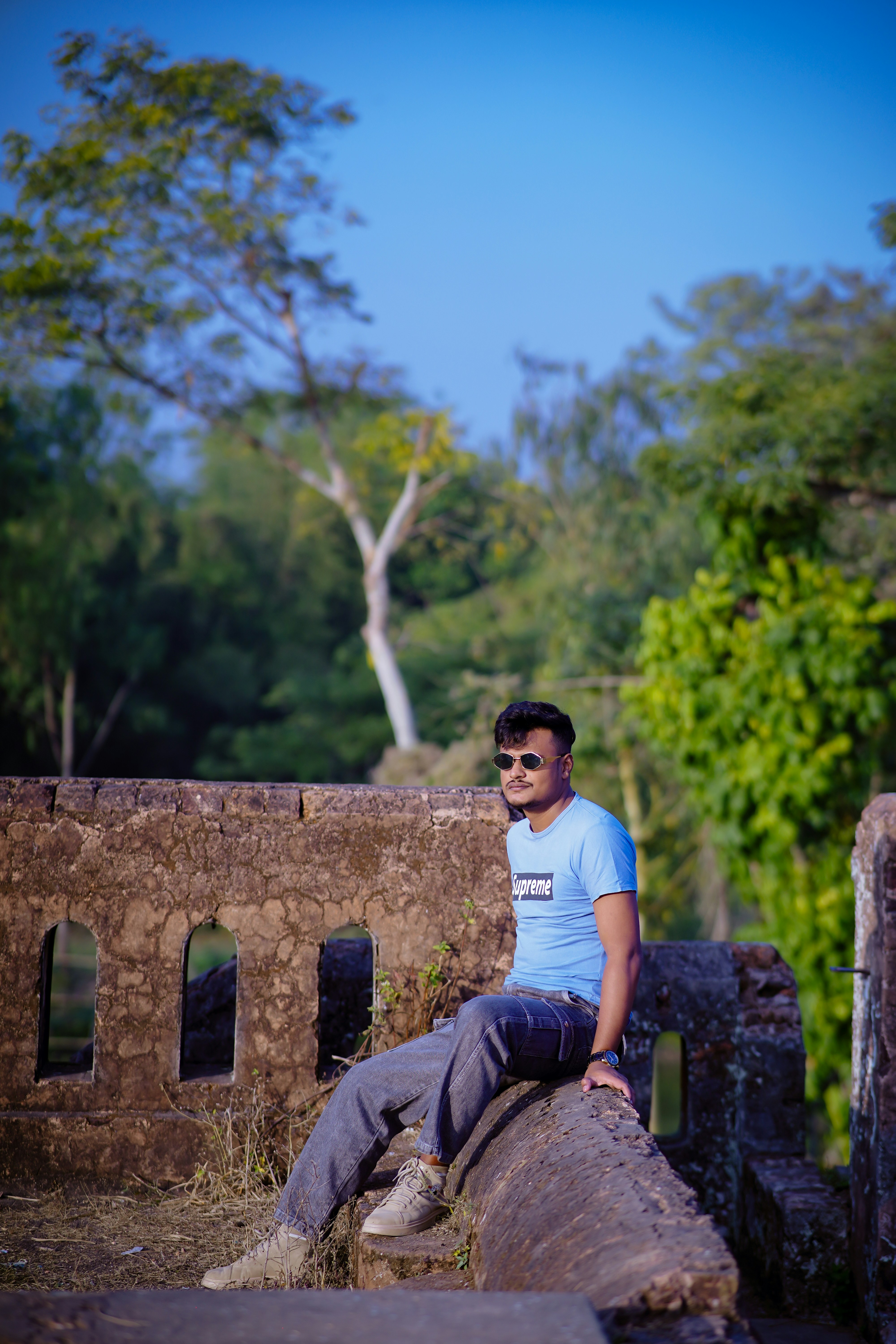Ridgeside Quiet: A Sunglasses-wearing Moment on the Stone Parapet