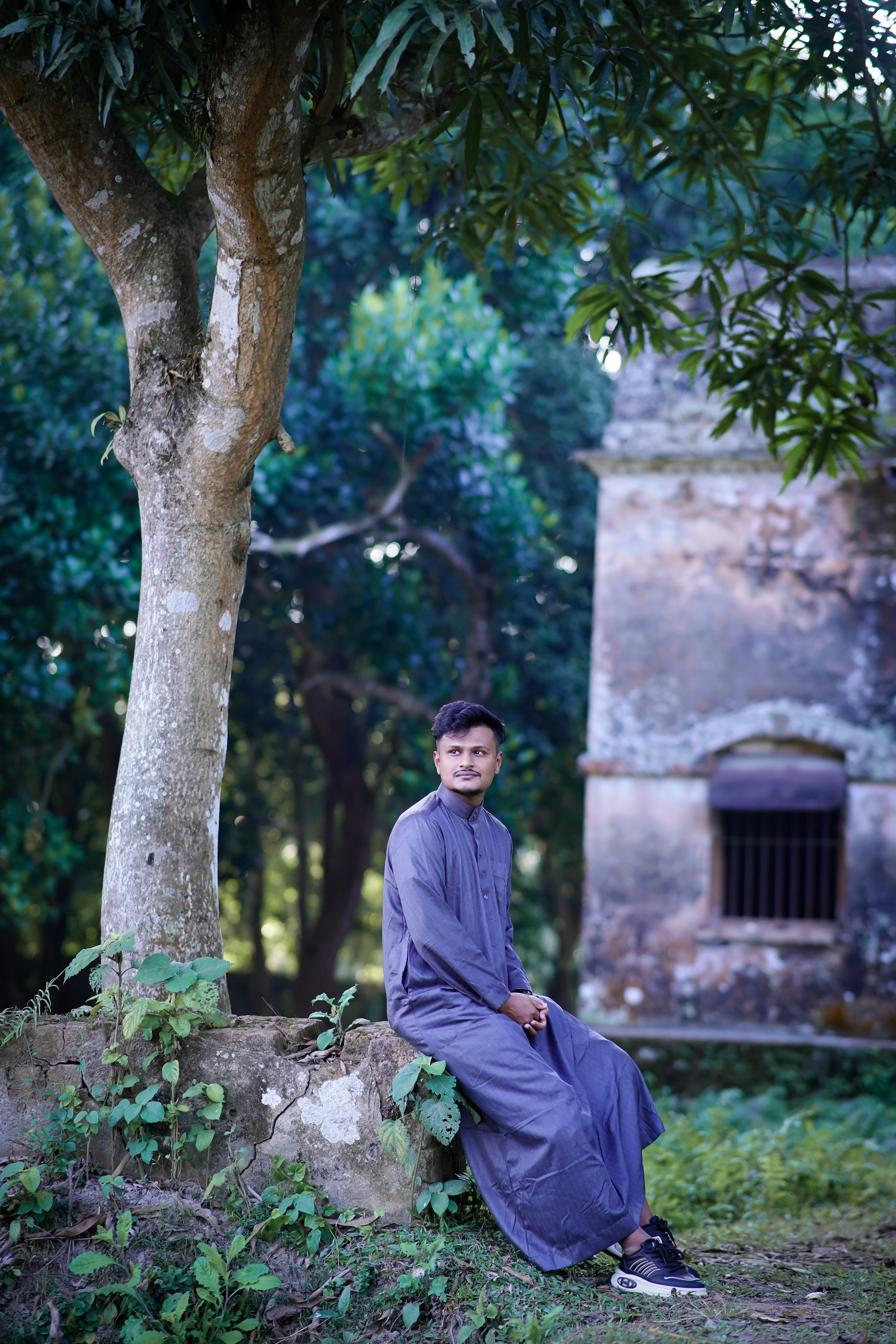 Gentleman in Indigo: A Quiet Moment by an Old Stone Wall