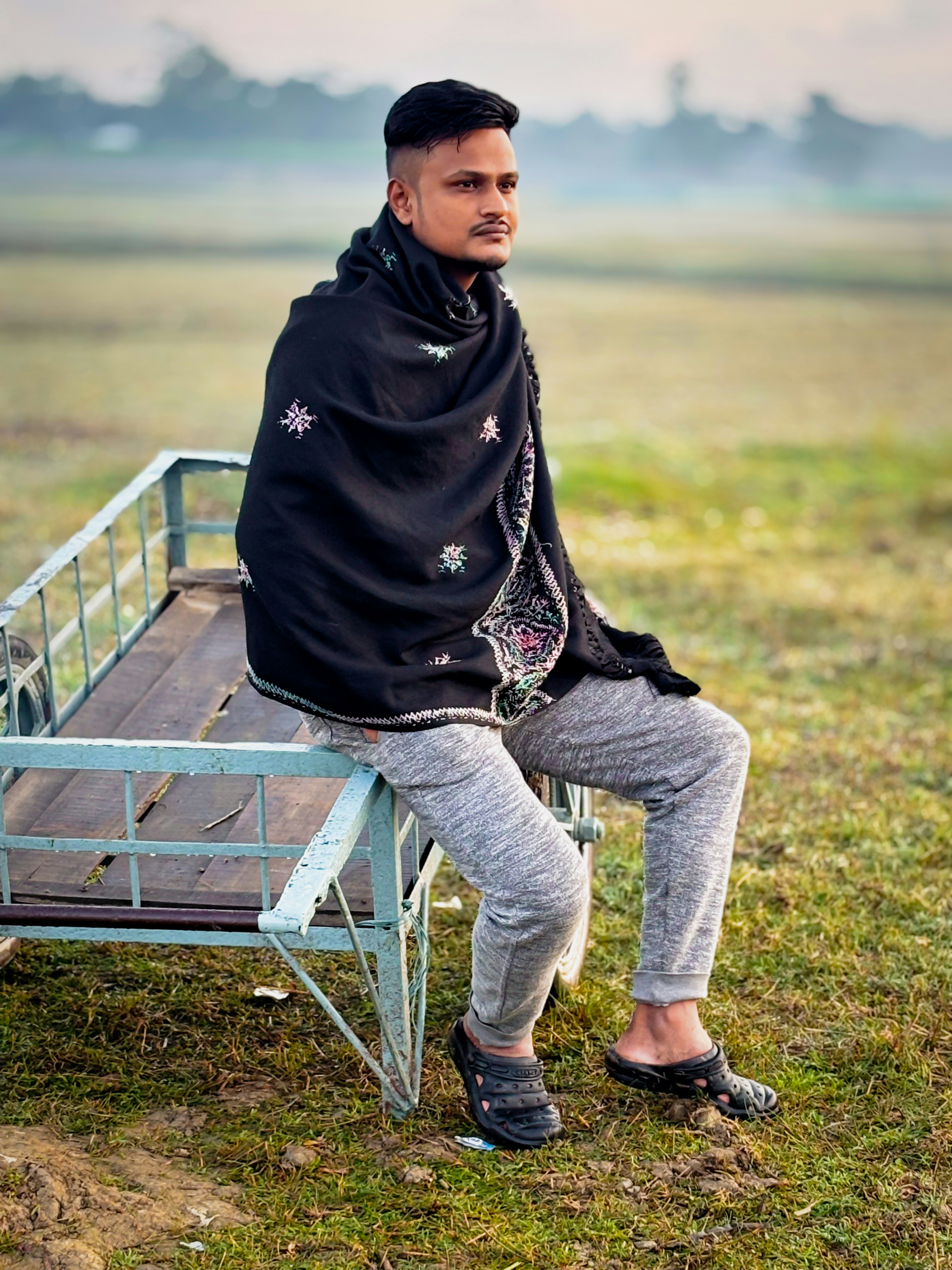 Wrapped in Night Sky: A Quiet Portrait on a Rural Bench
