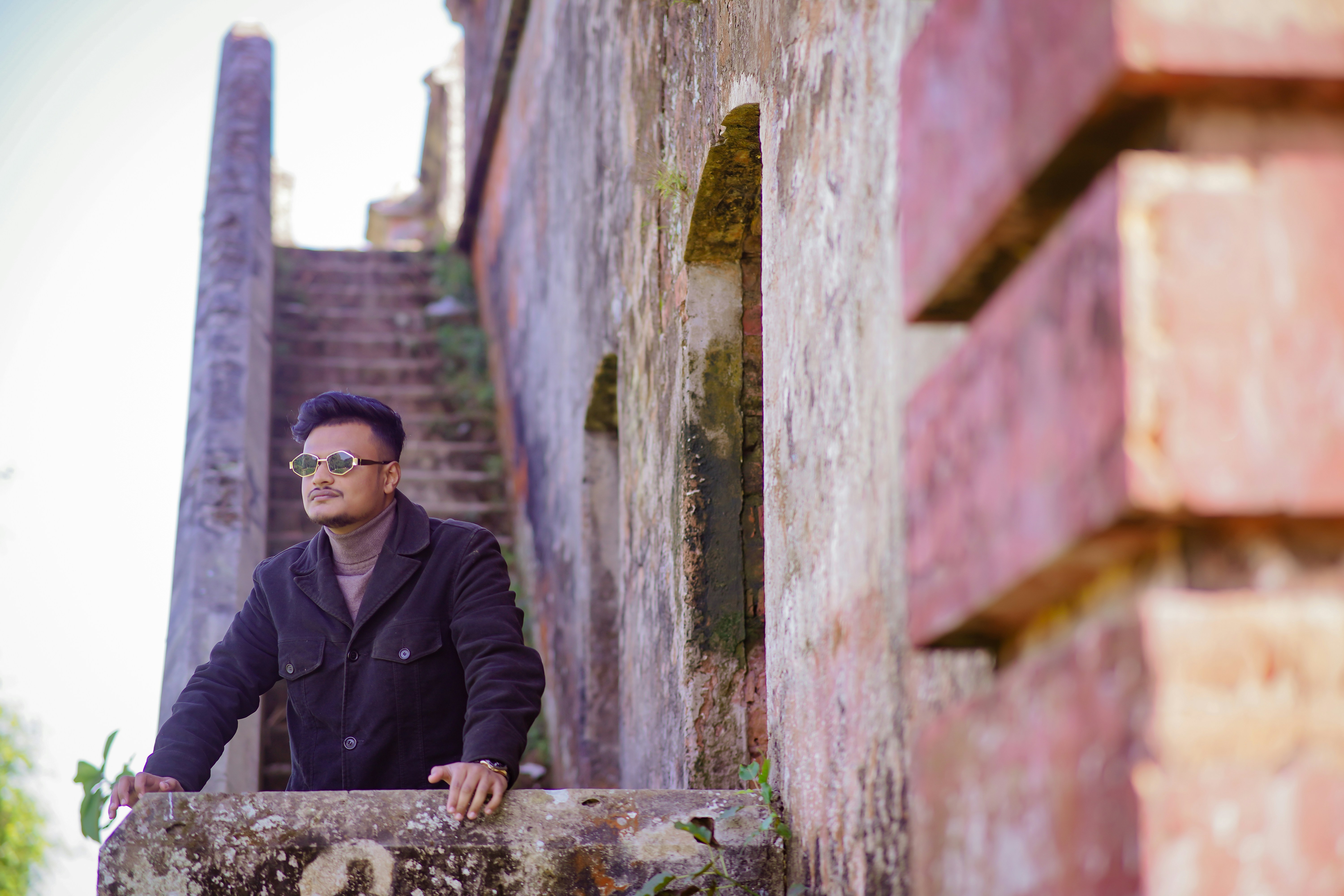 Stone Staircase Portrait: A Calm Gaze Behind Round Sunglasses