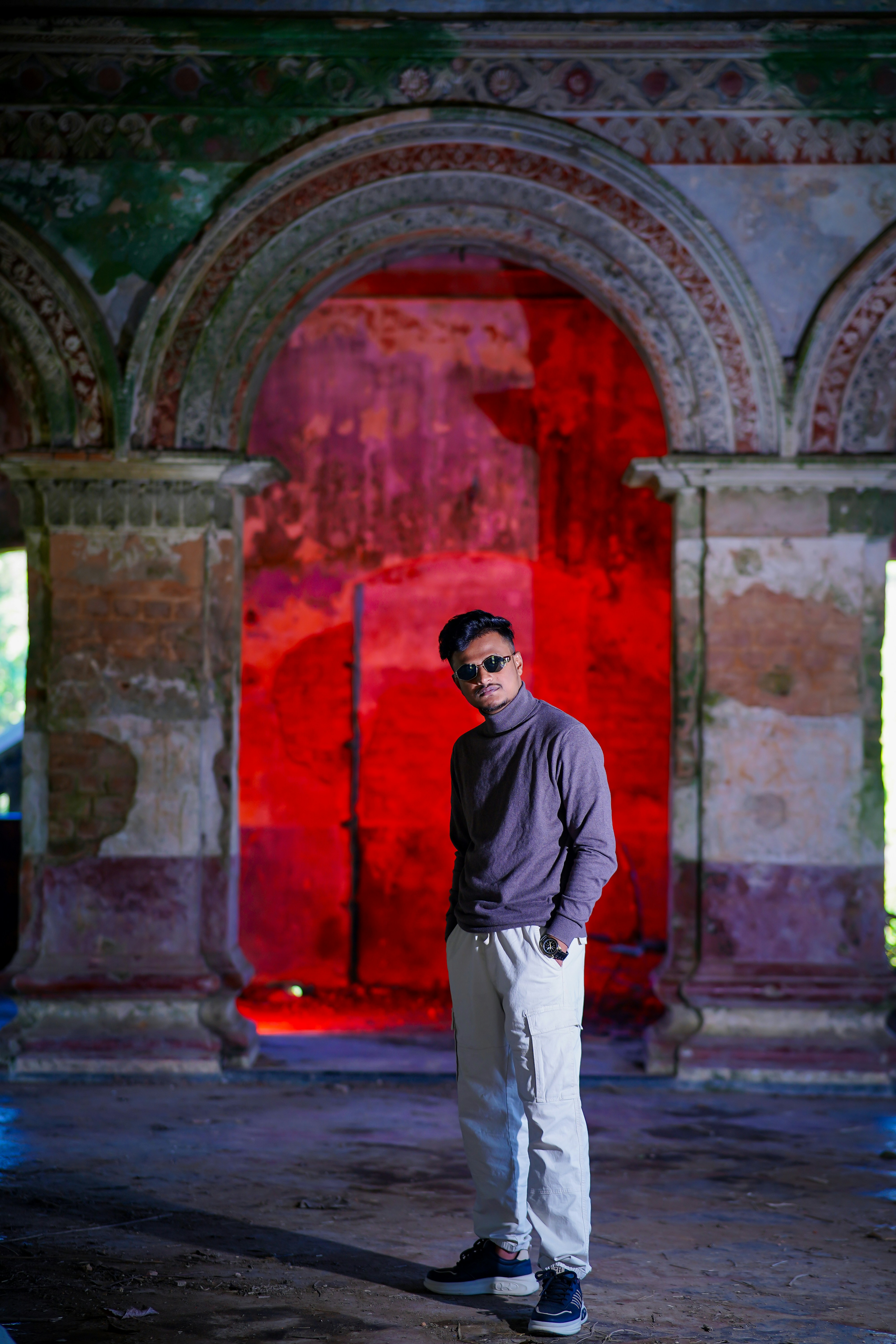 Portrait beneath a Painted Archway with Neon-Red Backlight