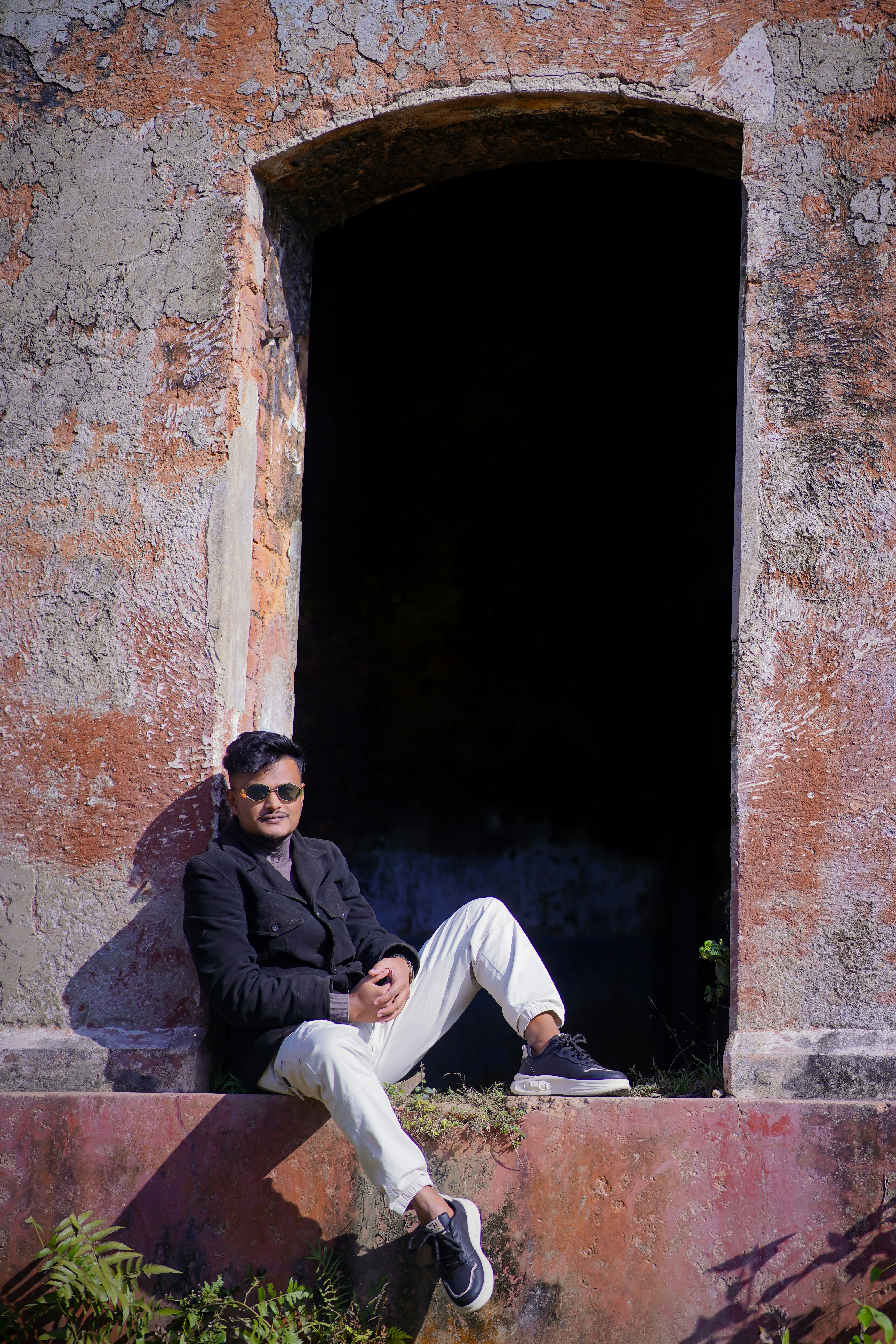 Solitary Figure at the Threshold: Portrait in a Weathered Archway