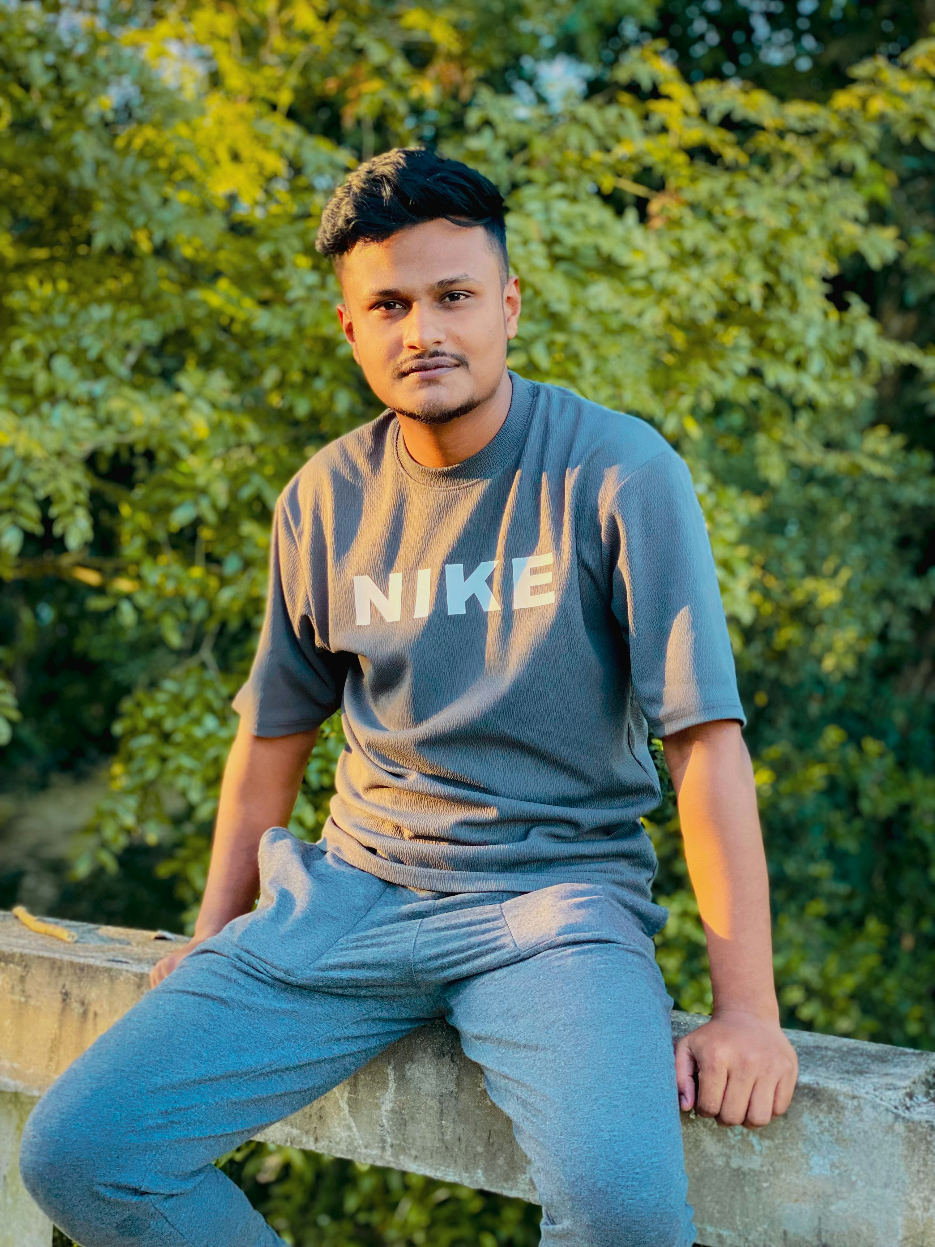Portrait on the verge of daylight: a calm sitter in a Nike tee