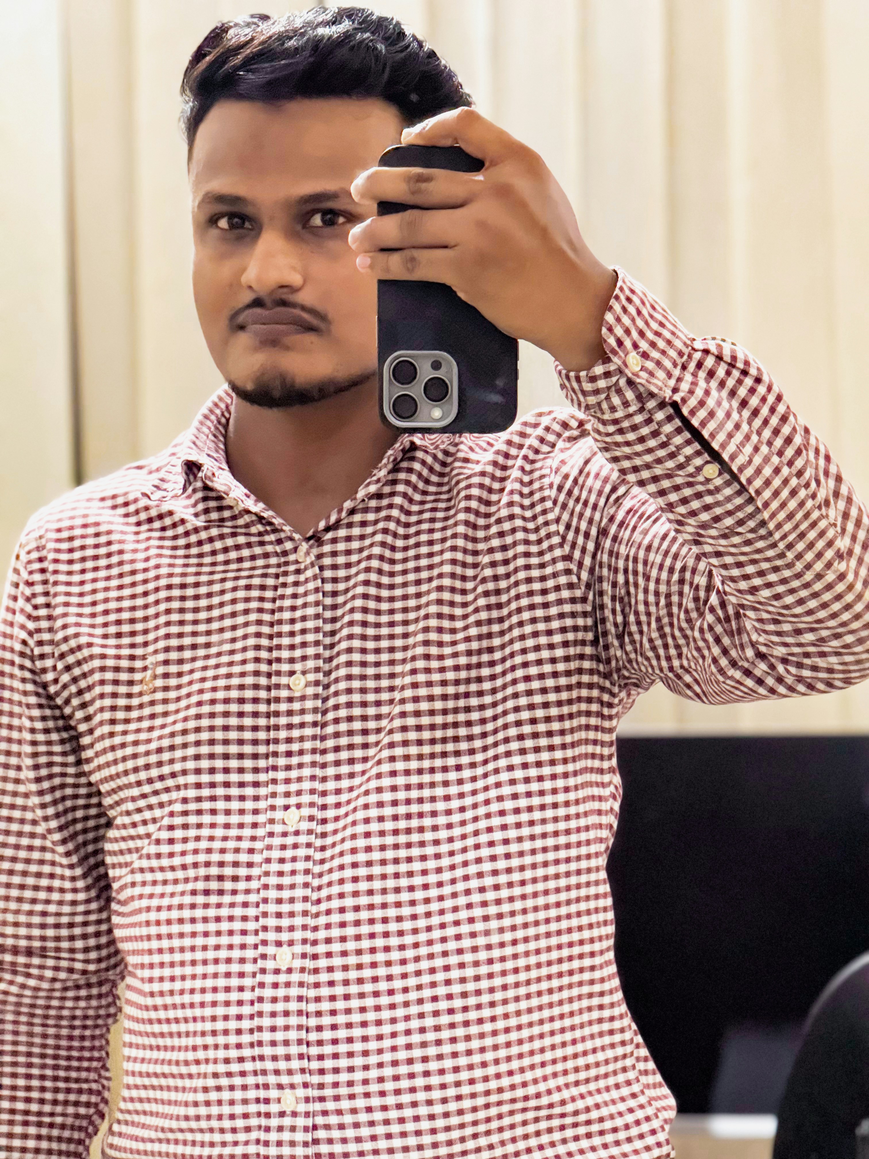 Self-Contained Focus: A Crisp Self-Portrait in a Checkered Shirt