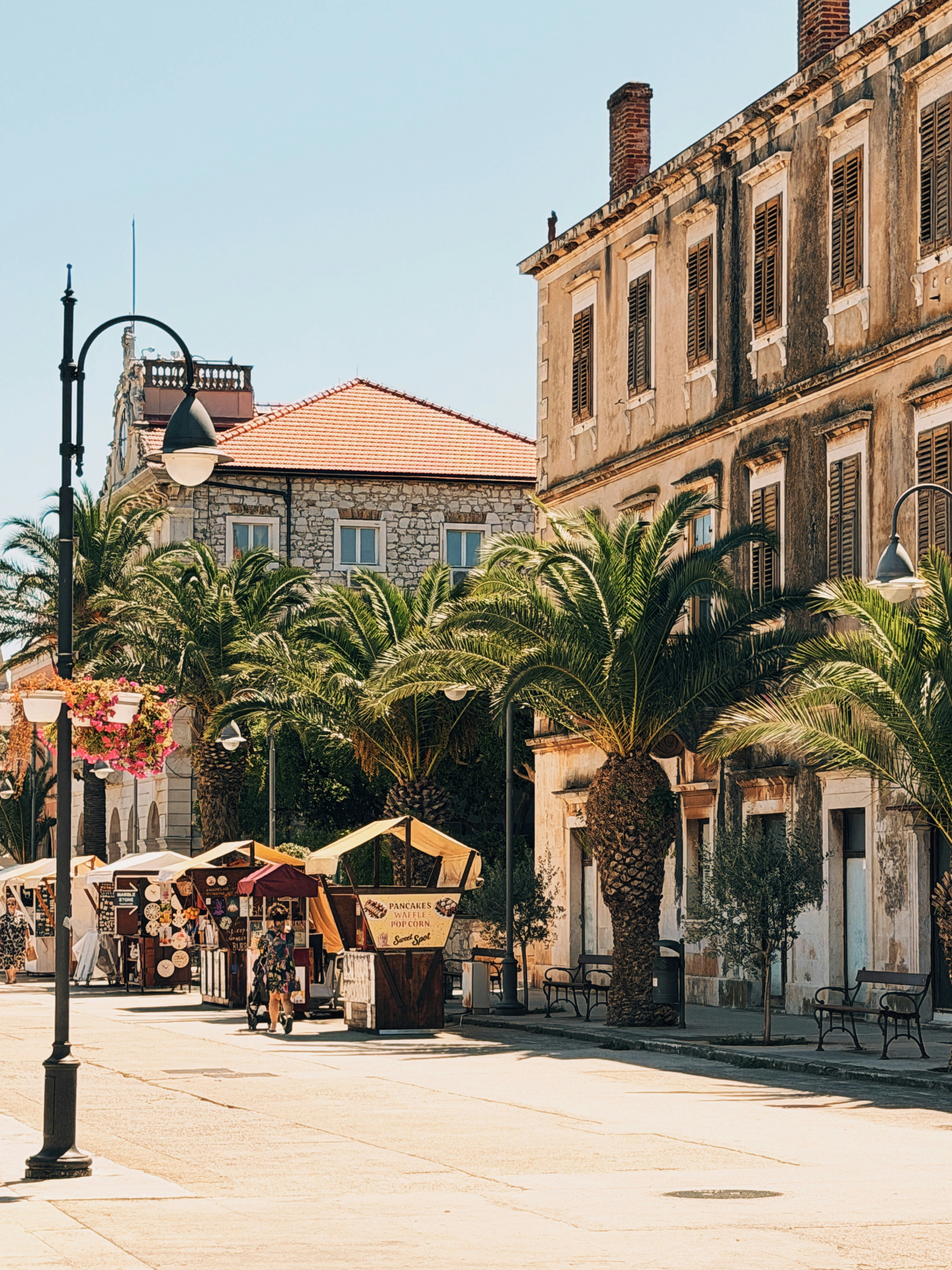 Sunlit Plaza with Palms and Colonial Facade