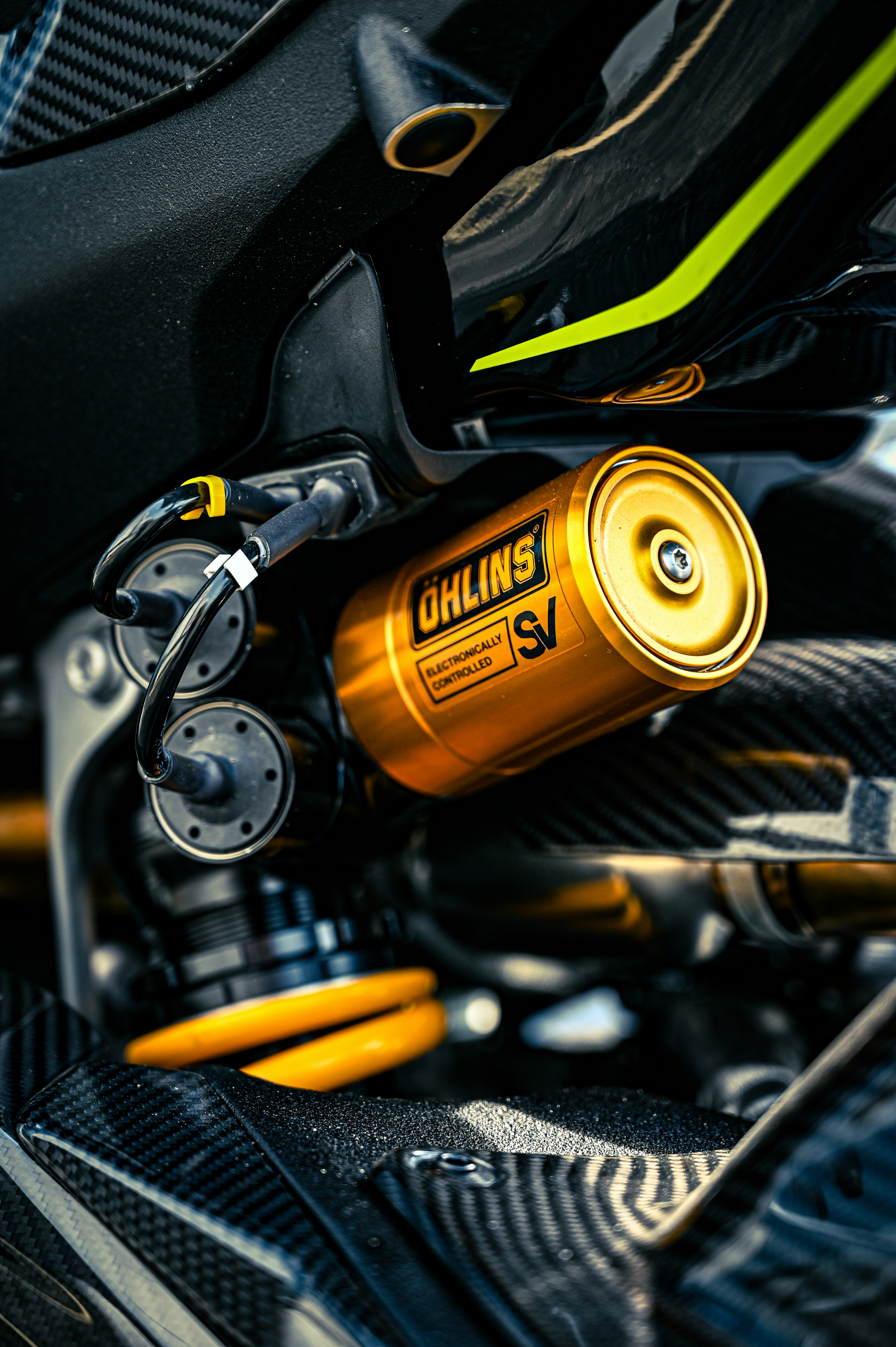 Golden Öhlins Peak: Close-Up of a High-Performance Motorcycle Shock and Canister