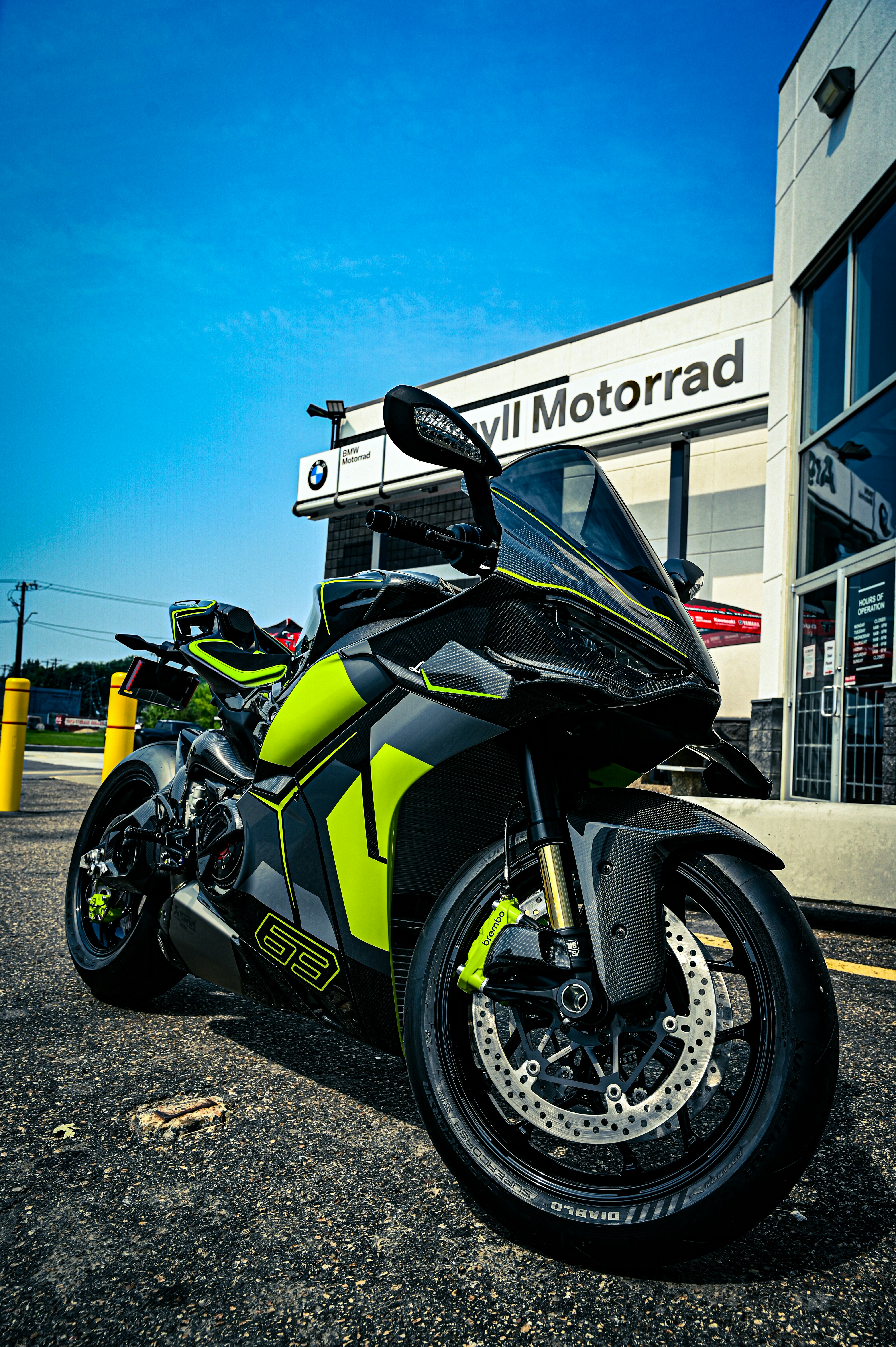 Neon-green sportbike at a BMW Motorrad service hub