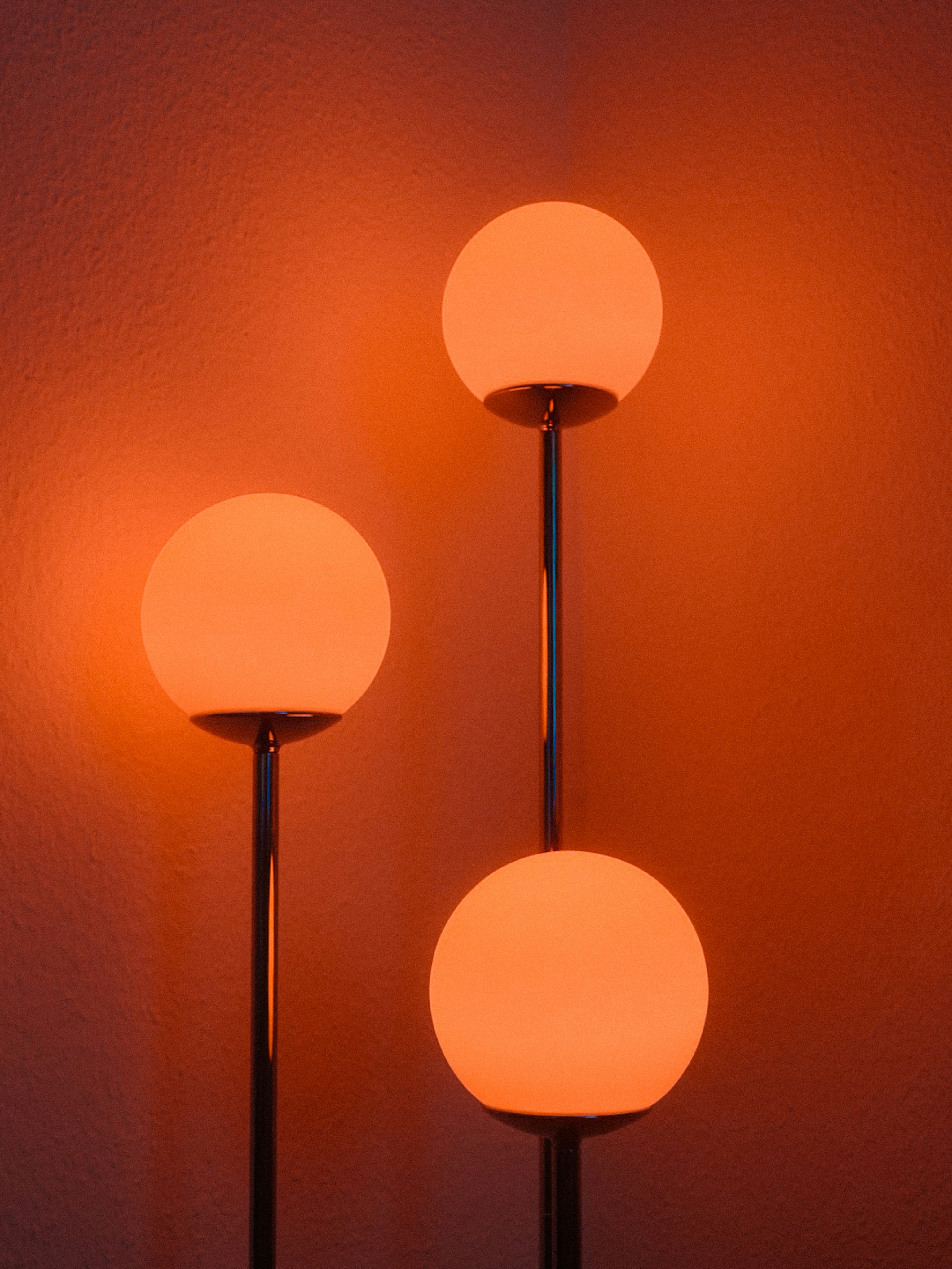 Warm Orbs on Stems: A Minimal Night-Lit Trio