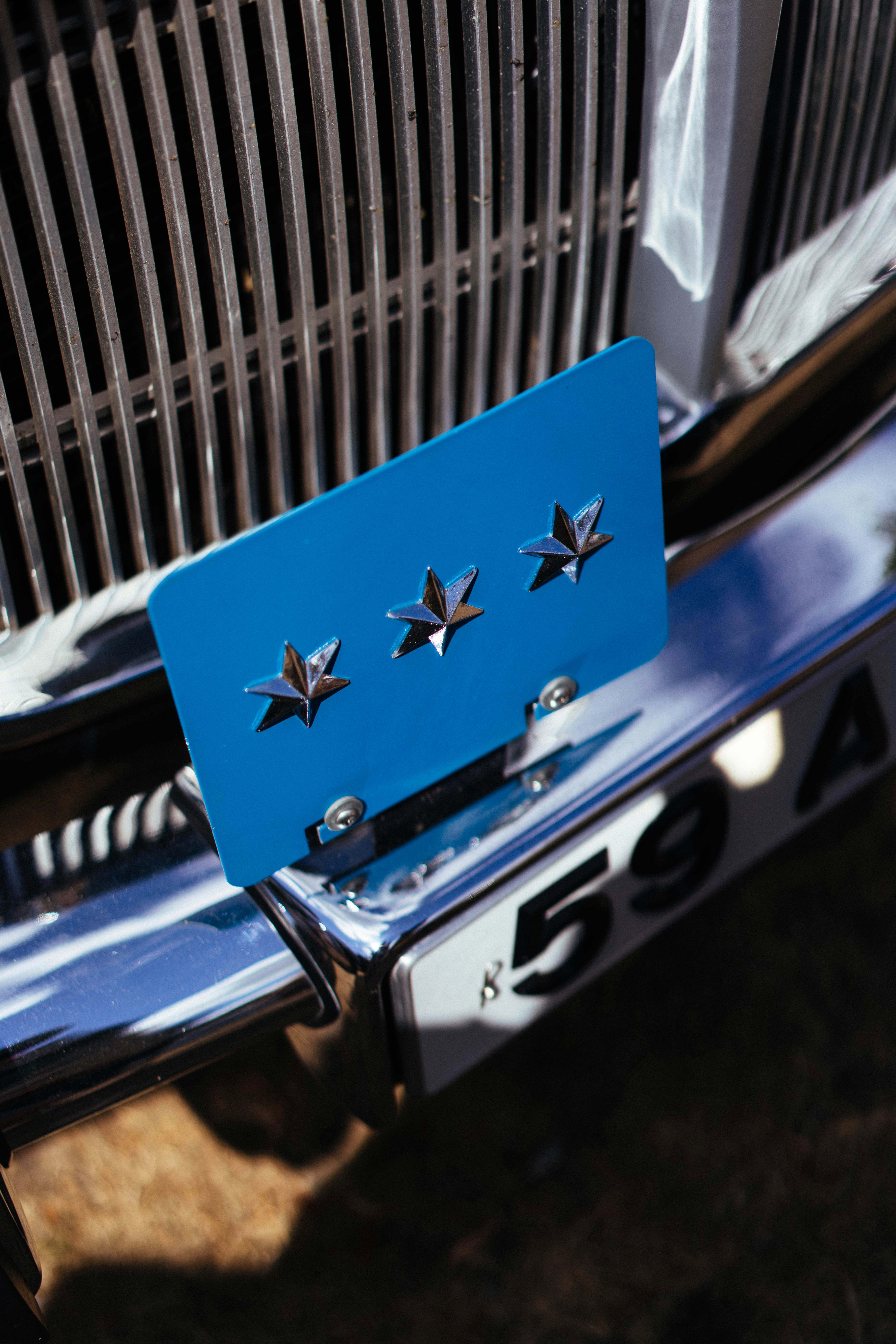 Blue Star Emblems on a Classic Car Grill