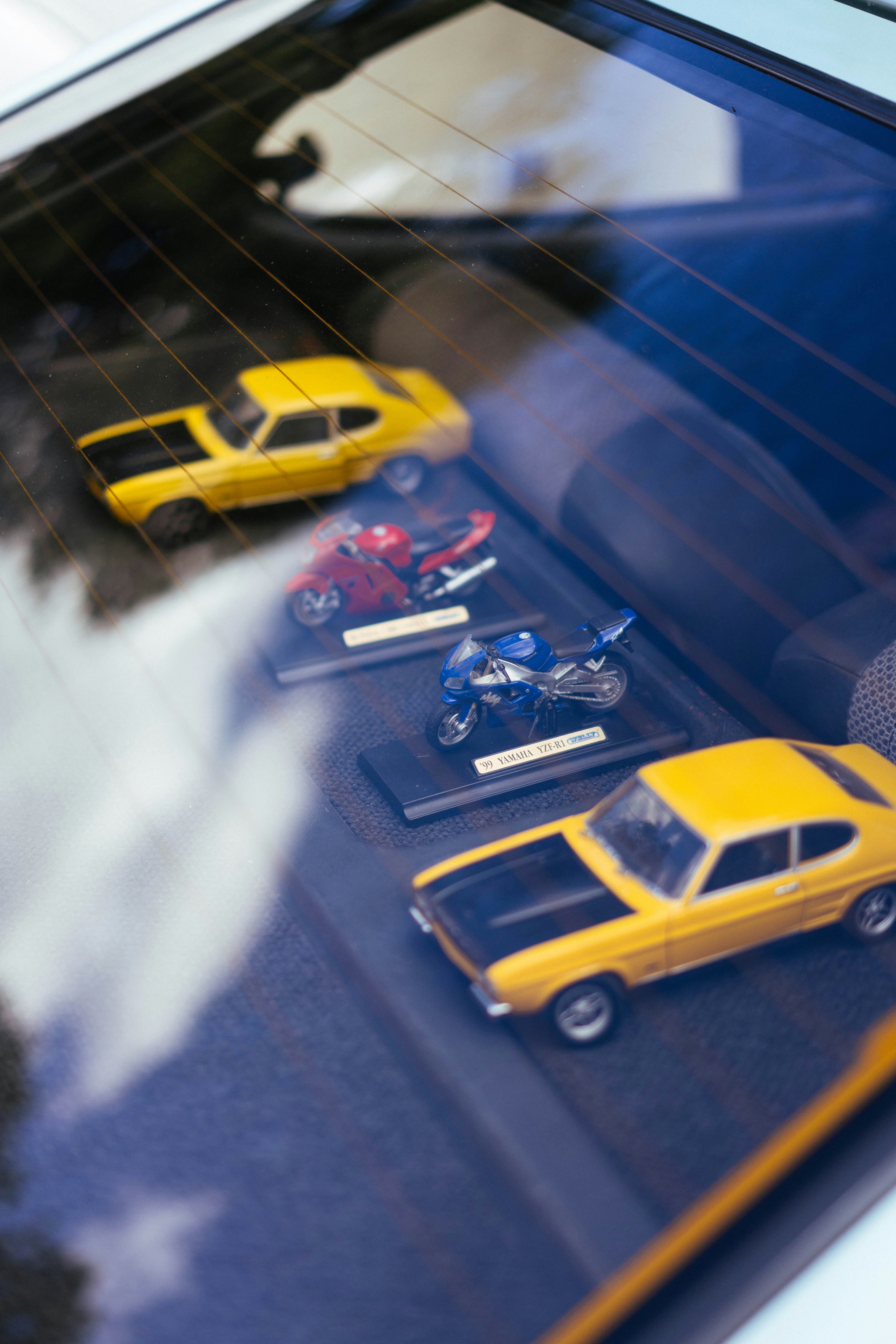 Toy Cars in a Window: Miniature Display with Glancing Reflection