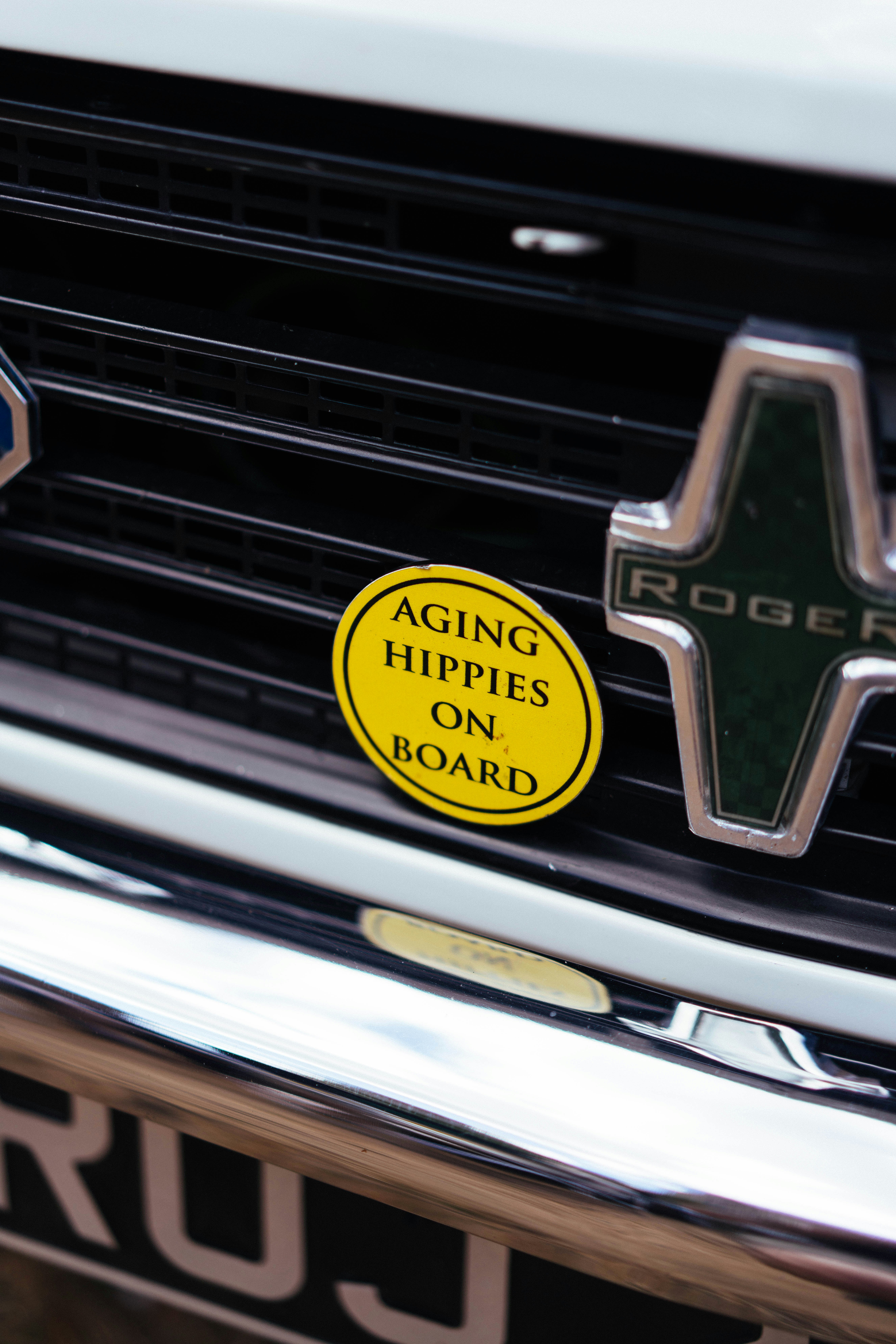 A Yellow Badge on Chrome Grille: A Closer Look at a Classic Car Emblem
